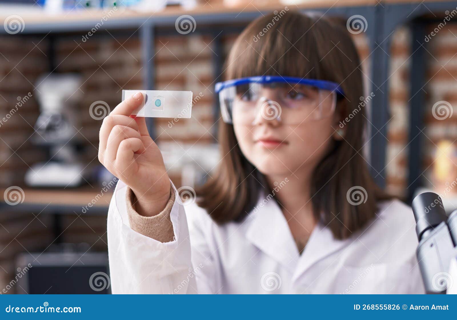 Adorable Hispanic Girl Student Looking Sample at Laboratory Classroom ...
