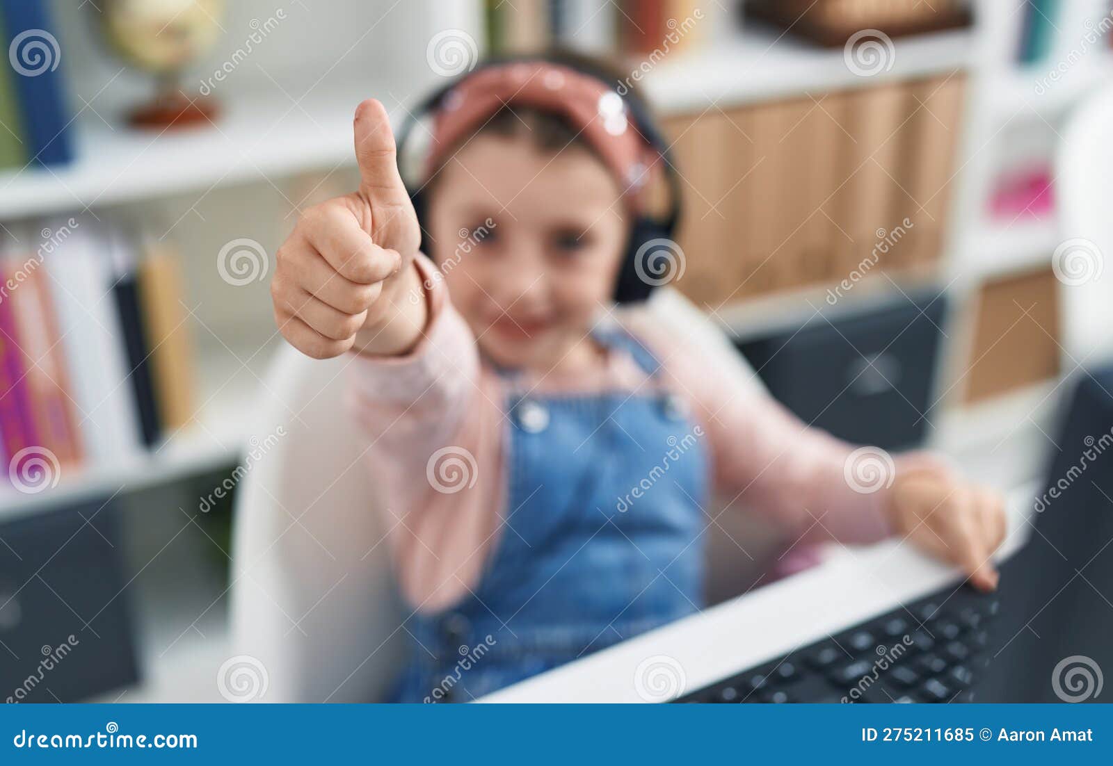 Adorable Hispanic Girl Student Using Computer Doing Thumb Up Gesture at ...