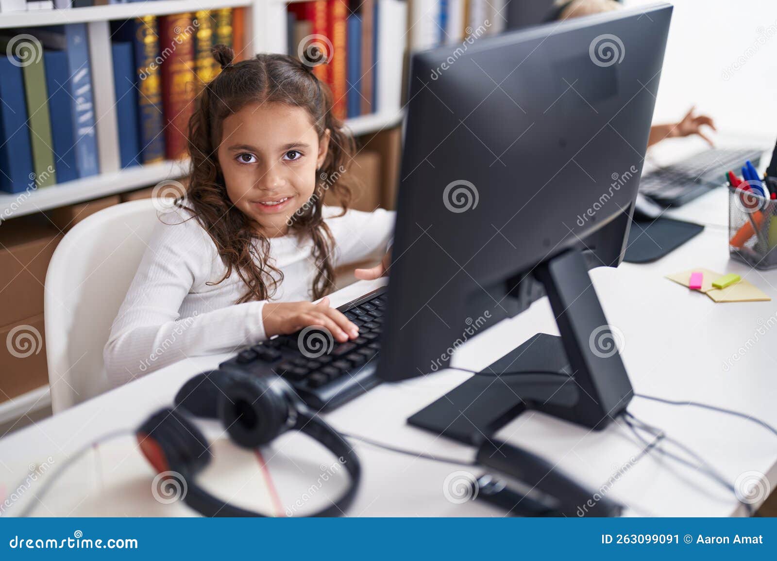 Adorable Hispanic Girl Student Using Computer Sitting on Table at ...