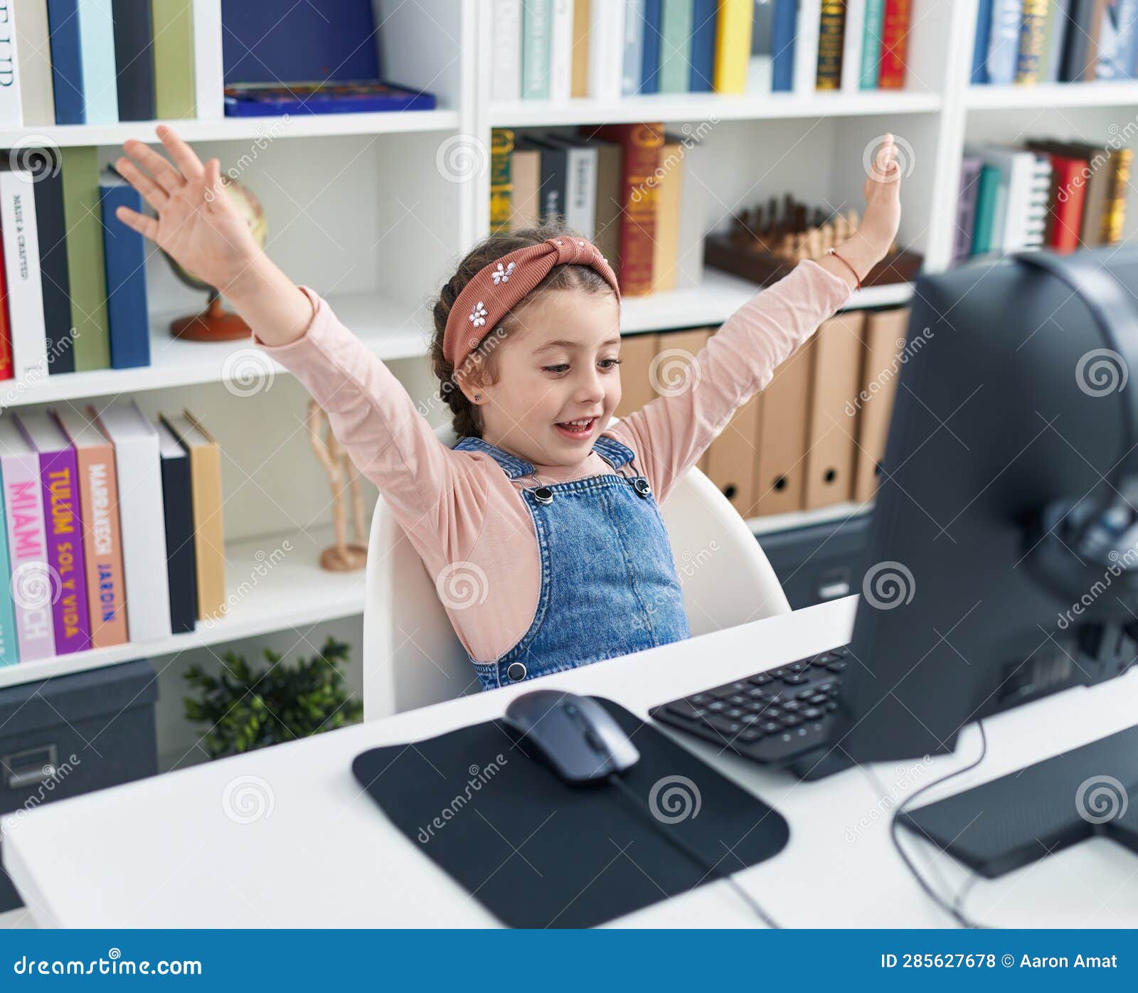 Adorable Hispanic Girl Student Using Computer with Winner Expression at ...
