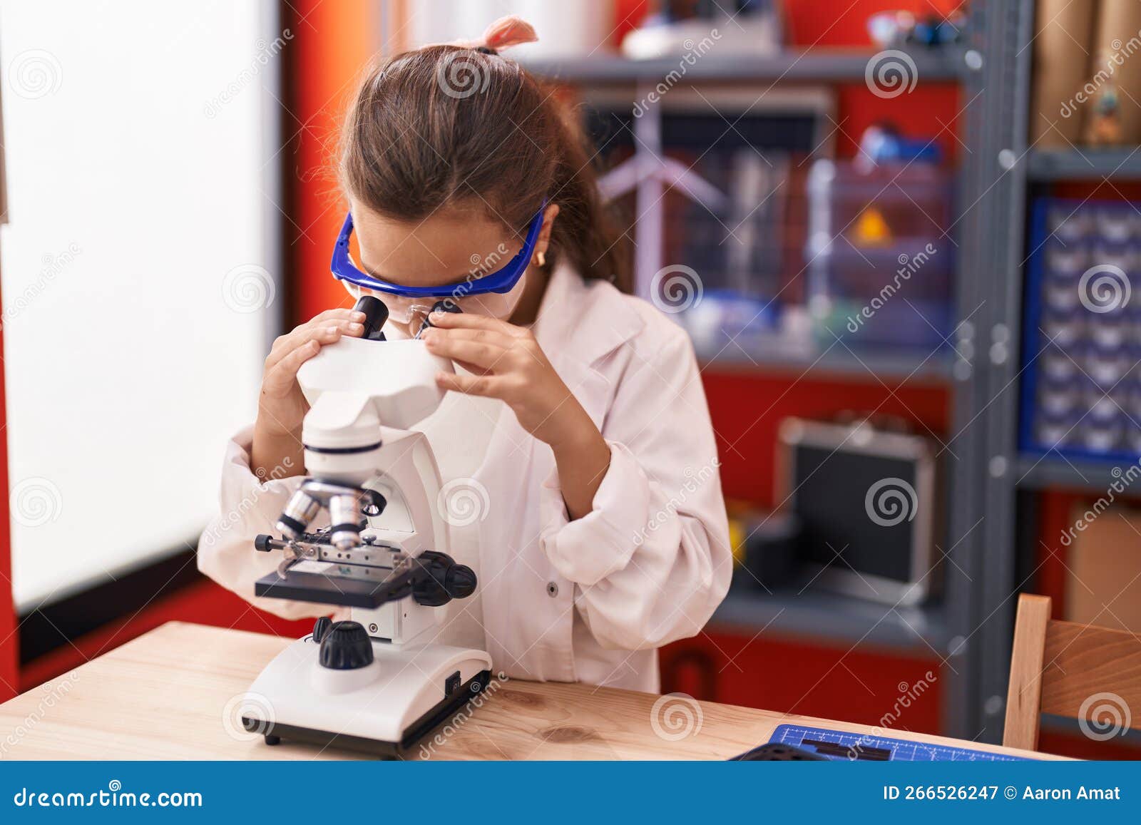 Adorable Hispanic Girl Student Using Microscope at Classroom Stock ...