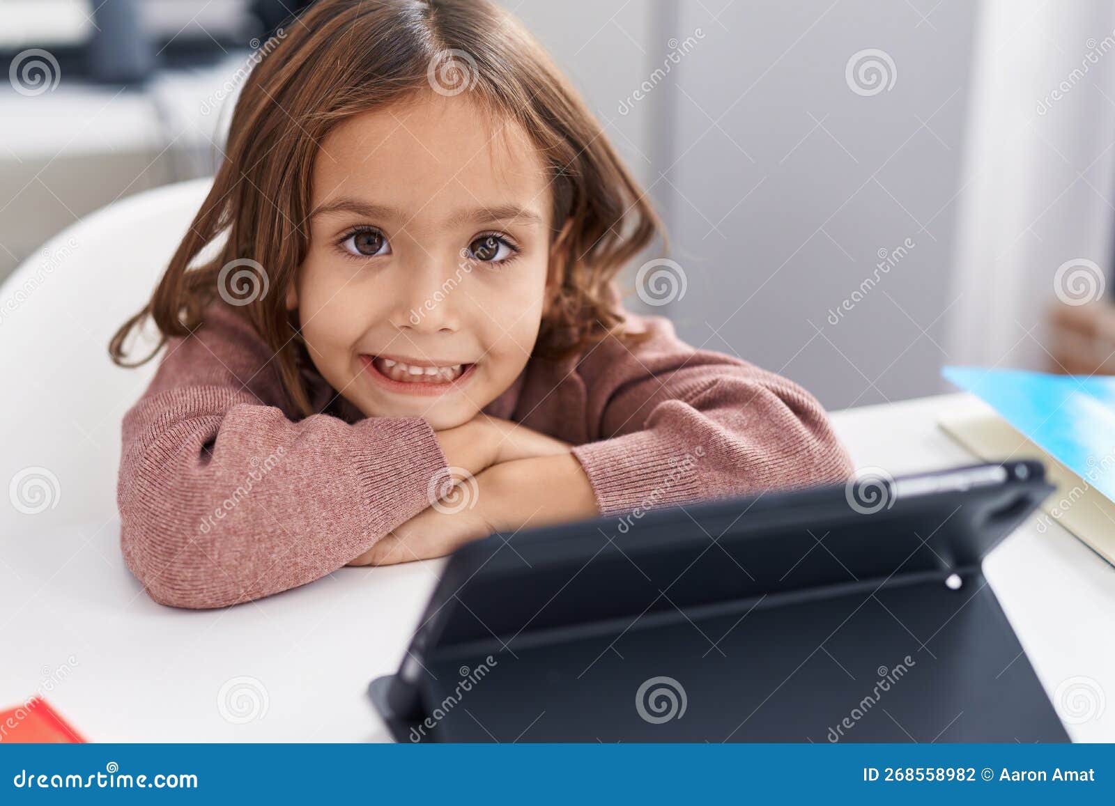 Adorable Hispanic Girl Student Using Touchpad Sitting on Table at ...