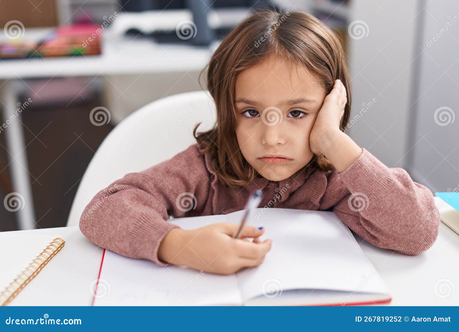 Adorable Hispanic Girl Student Writing on Notebook with Relaxed ...