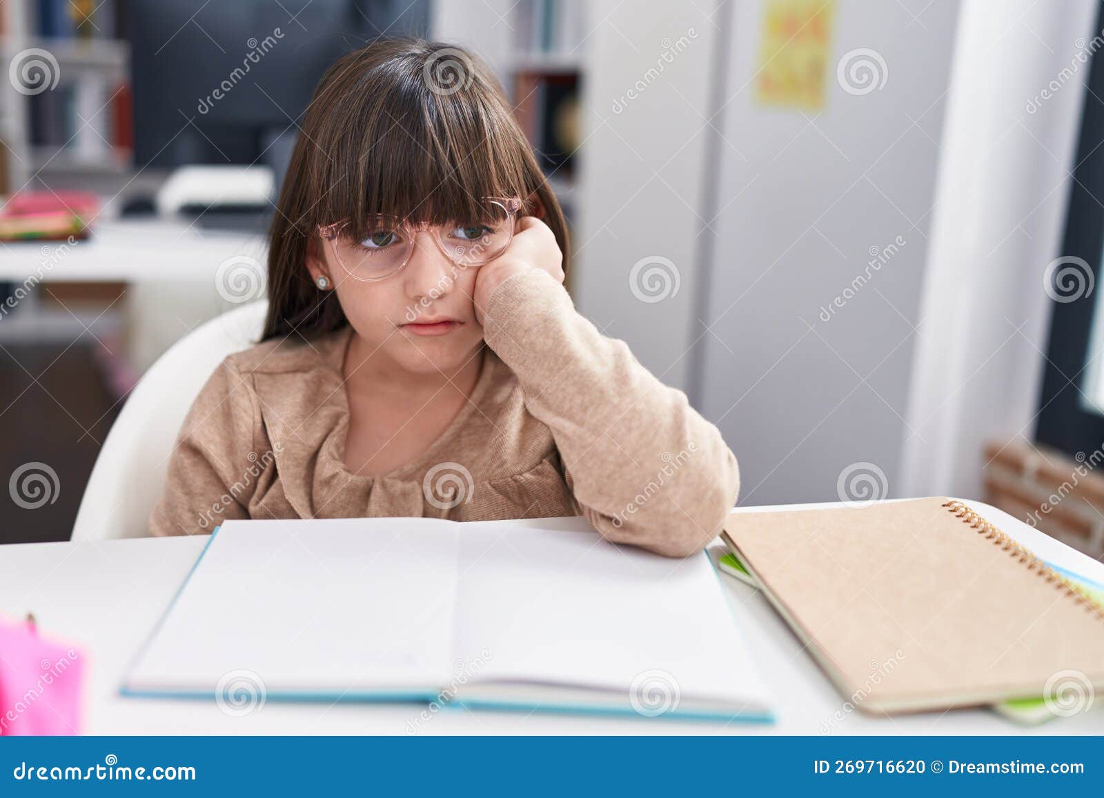 Adorable Hispanic Girl Student Writing on Notebook with Relaxed ...