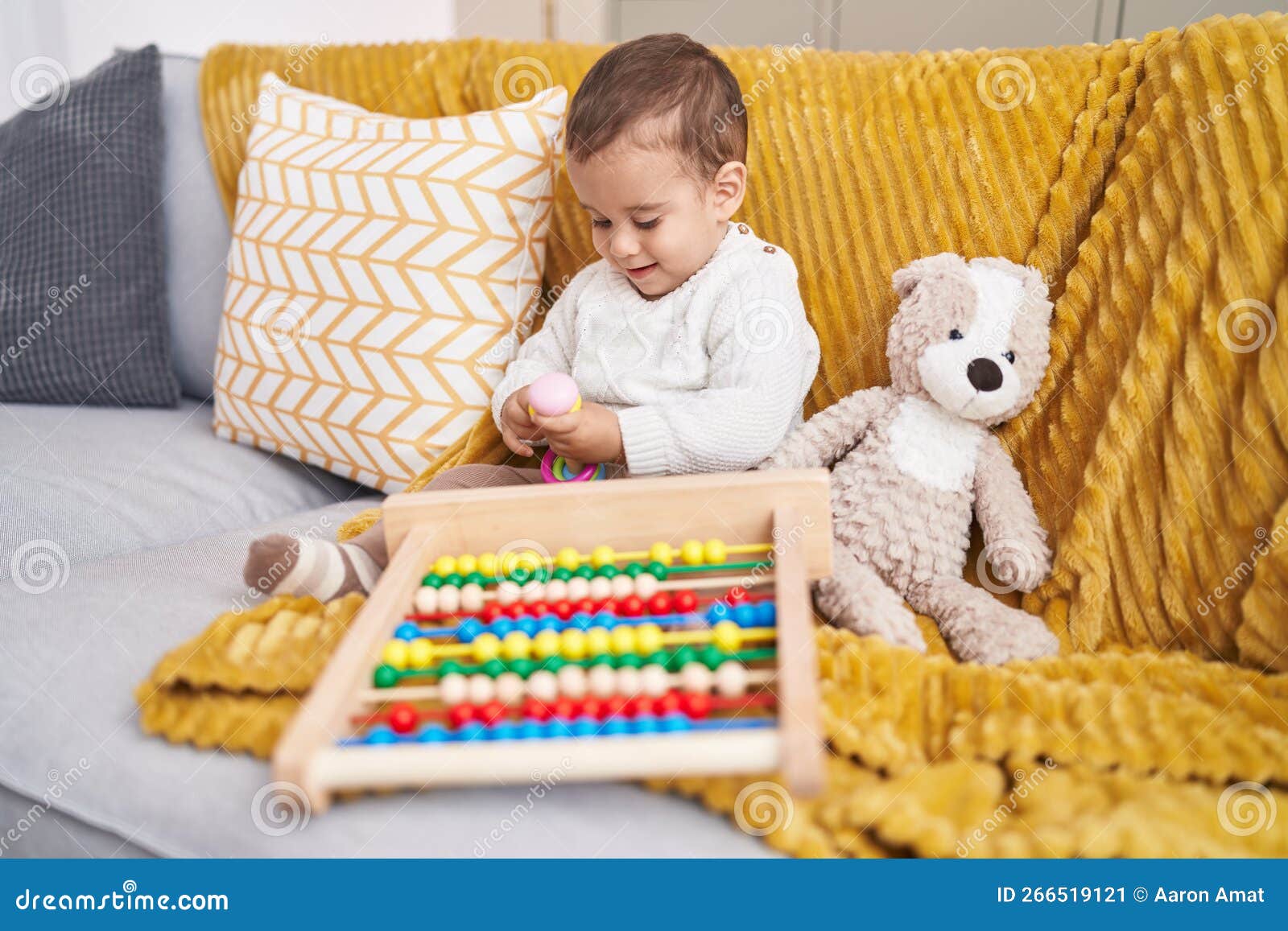 Adorable Hispanic Toddler Playing with Abacus Sitting on Sofa at Home ...