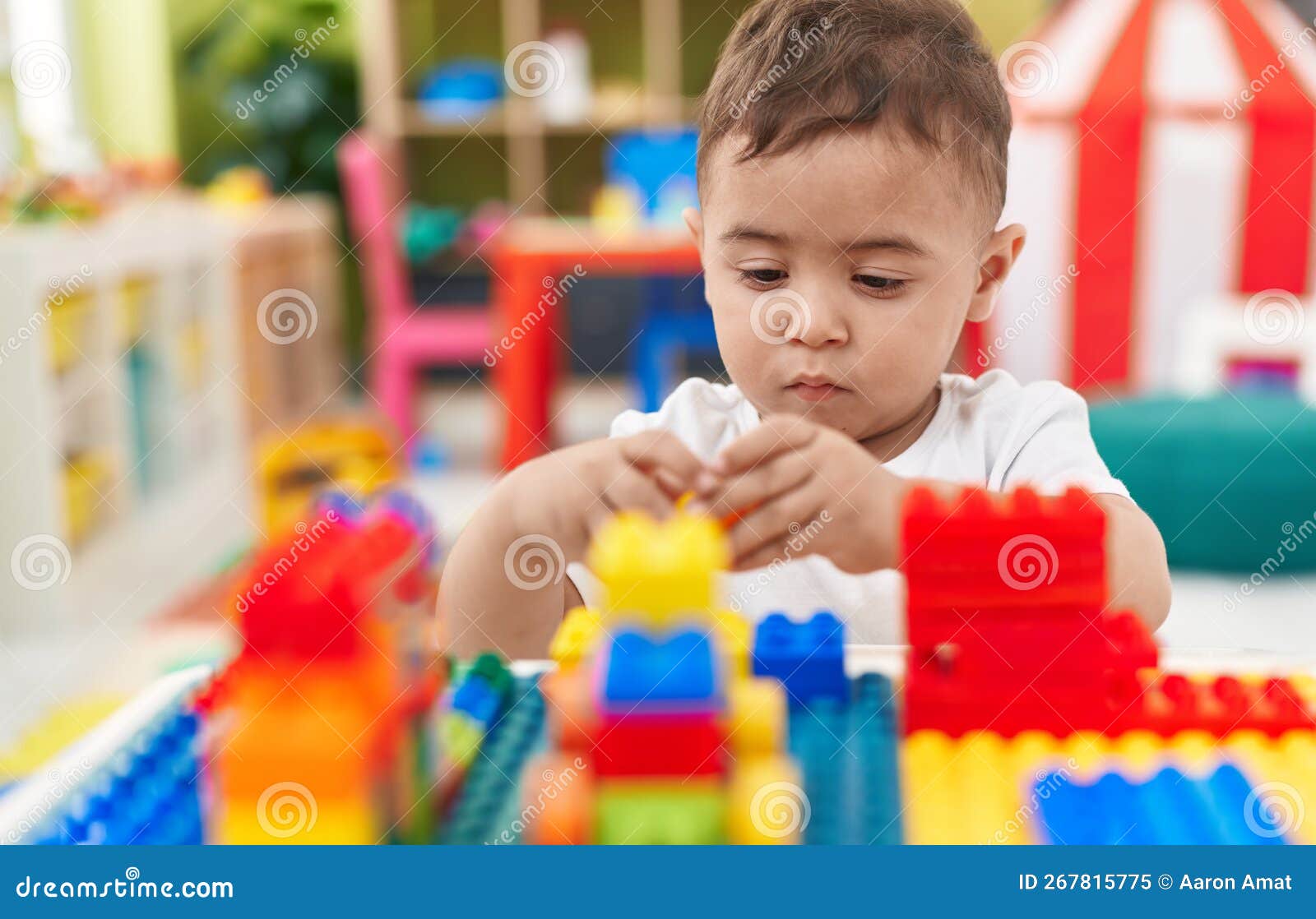Adorable Hispanic Toddler Playing with Construction Blocks Sitting on ...