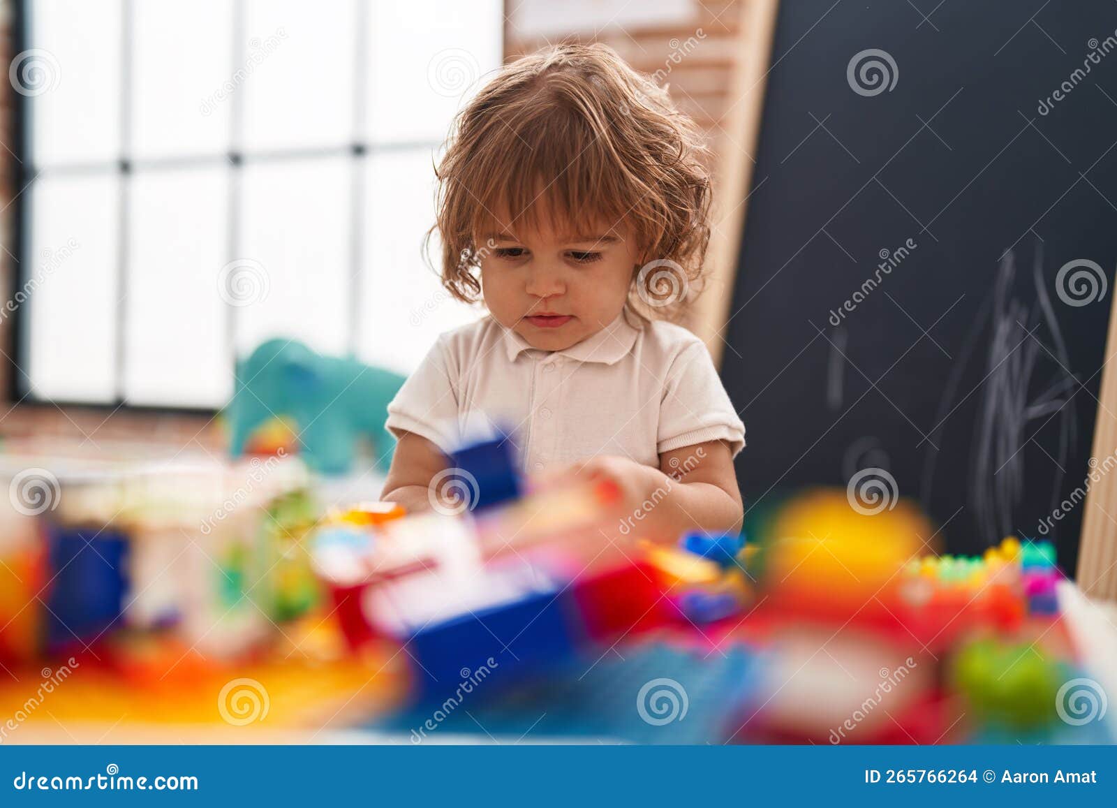 Adorable Hispanic Toddler Playing with Construction Blocks Standing at ...