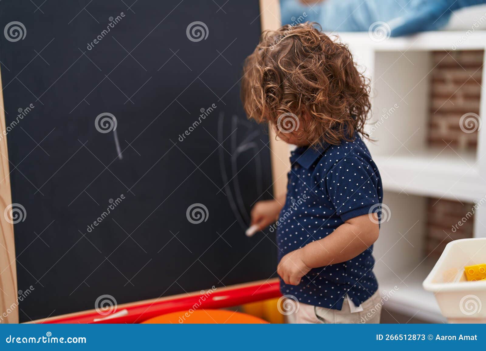Adorable Hispanic Toddler Student Drawing on Blackboard at Kindergarten ...