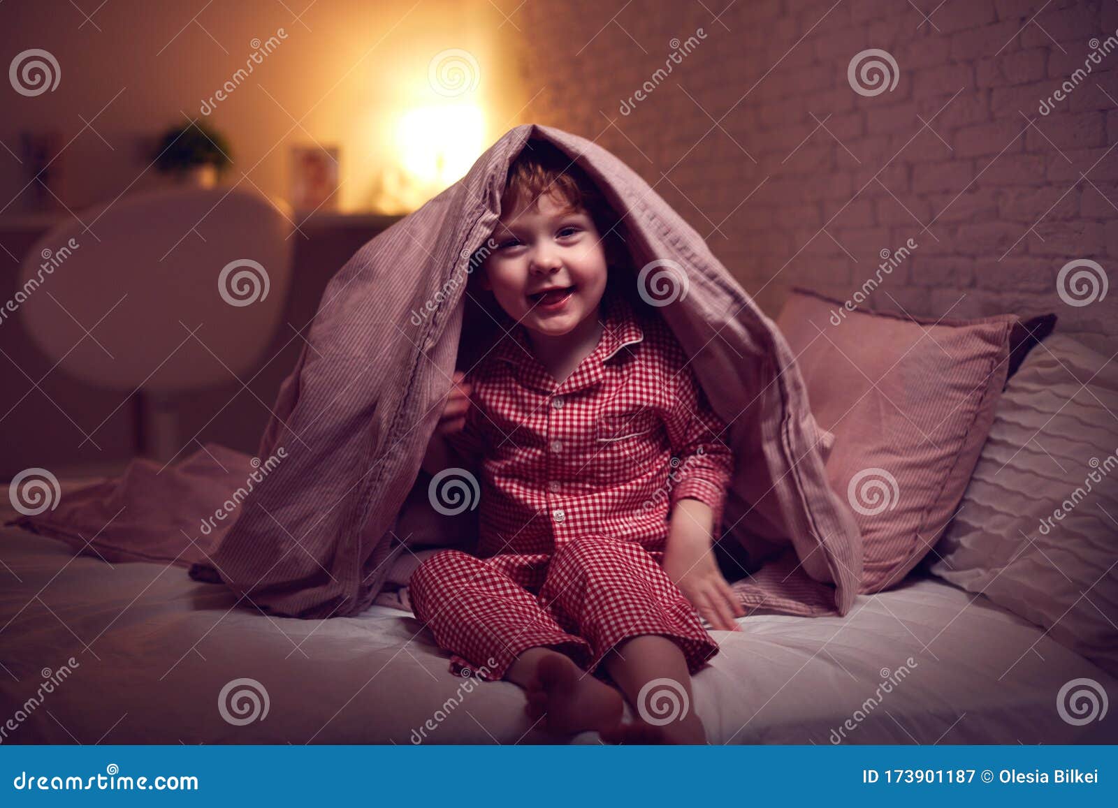 Adorable Laughing Baby Boy in Bed before Going To Sleep Stock Image ...