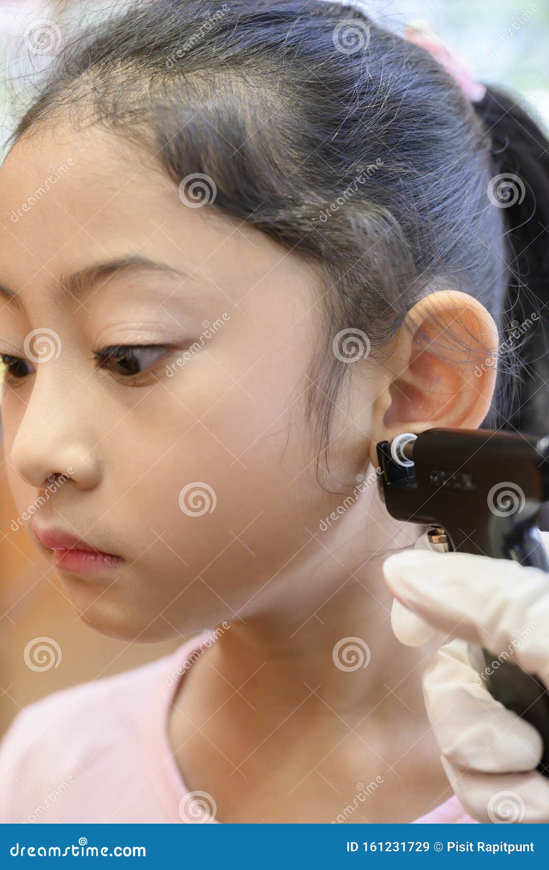 Adorable Little Asian Girl Having Ear Piercing Process. Stock Image ...