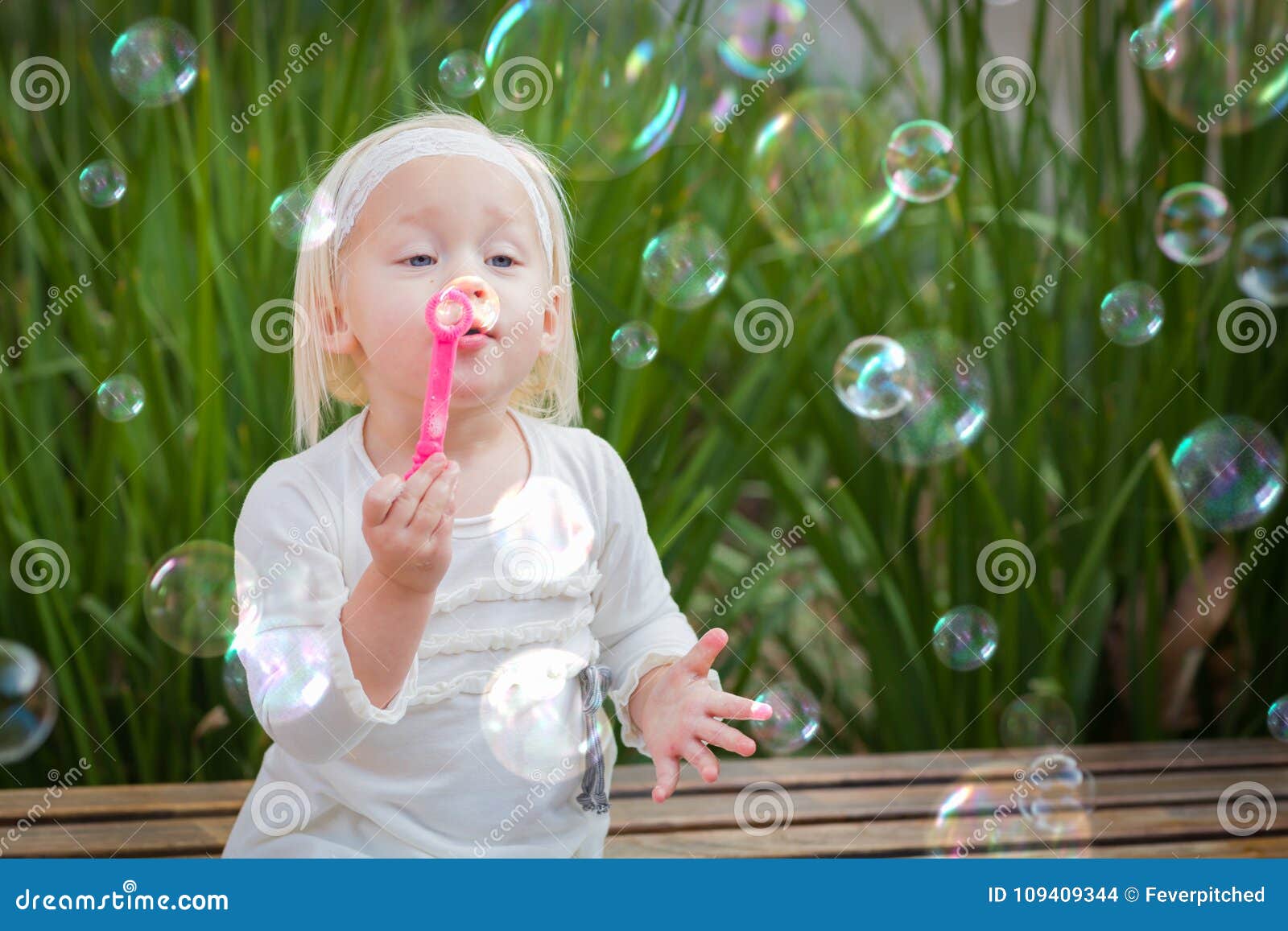 Adorable Toddler Girl Sitting on Bench Having Fun Blowing Bubbles Stock ... Adorable Toddler Girl Sitting on Bench Having Fun Blowing Bubbles Stock ...