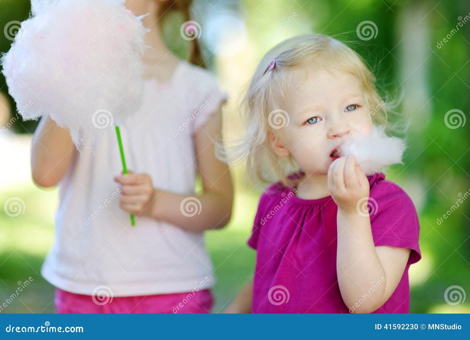 Adorable Little Sisters Eating Candy-floss Stock Photo - Image of ...