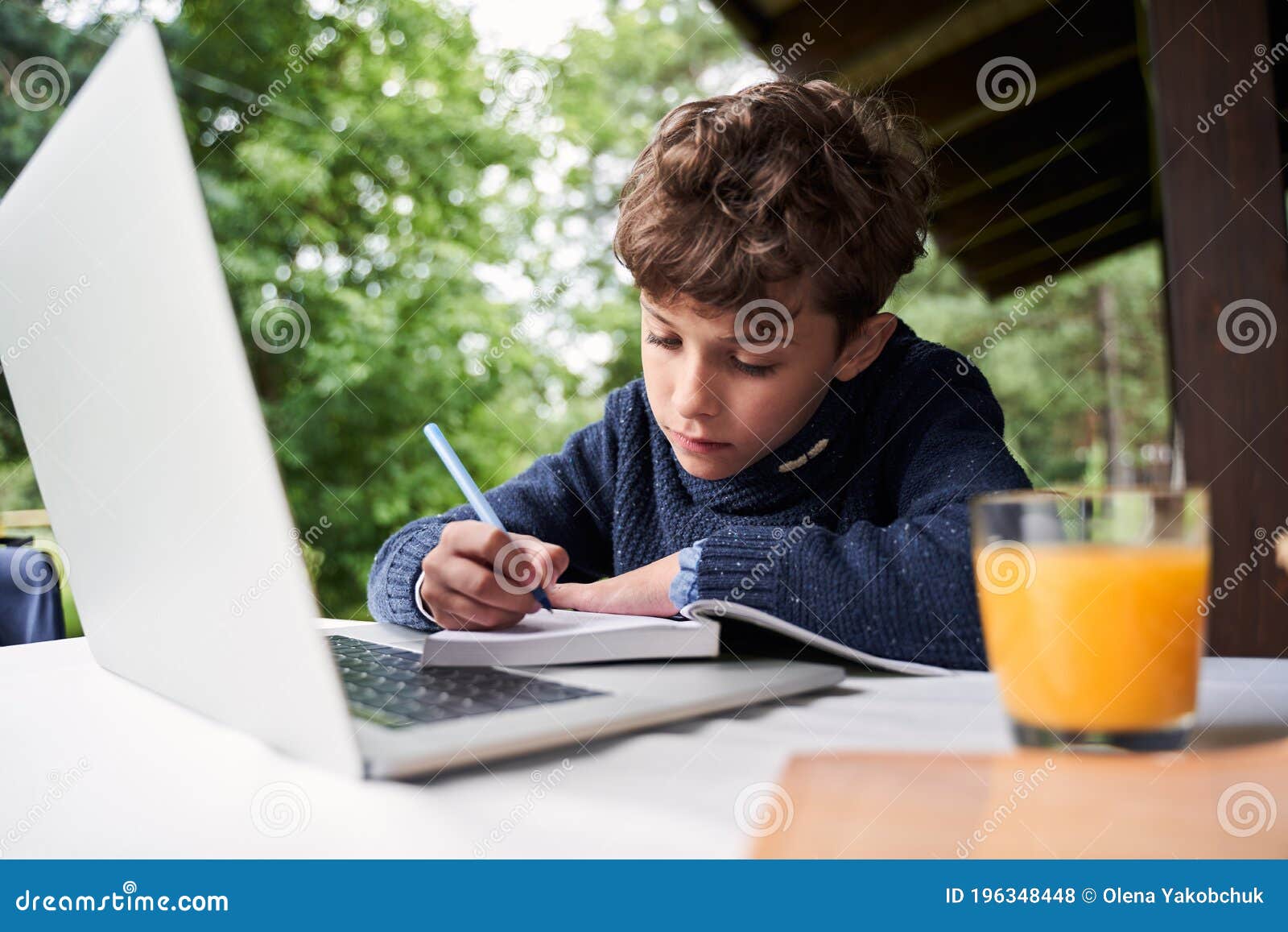 Cute Child Using Laptop and Writing in Notebook Outdoors Stock Photo ...