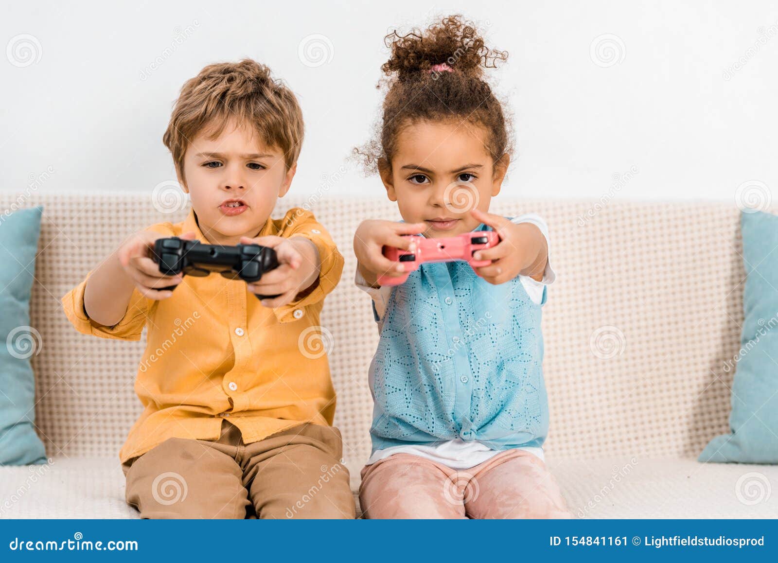 Adorable Multiethnic Kids Playing Video Game with Joysticks and Looking ...