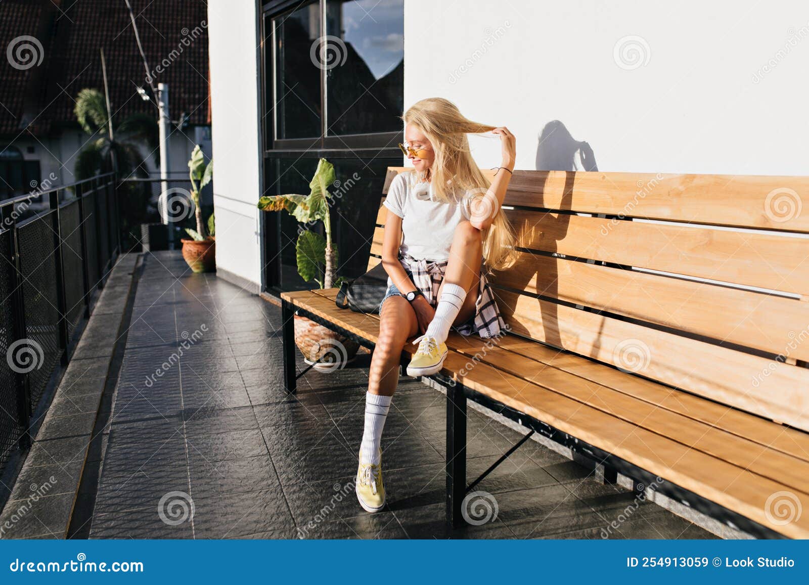 Adorable Tanned Woman In White Socks Playing With Long Blonde Hair