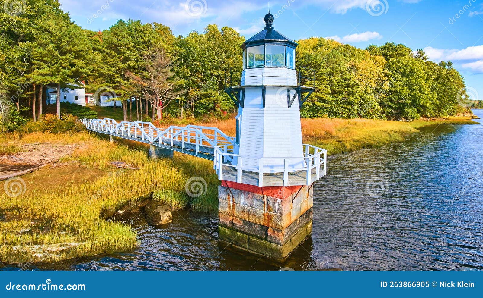 Adorable Tiny Lighthouse on Maine Coast with Walkway and Fall Foliage ...