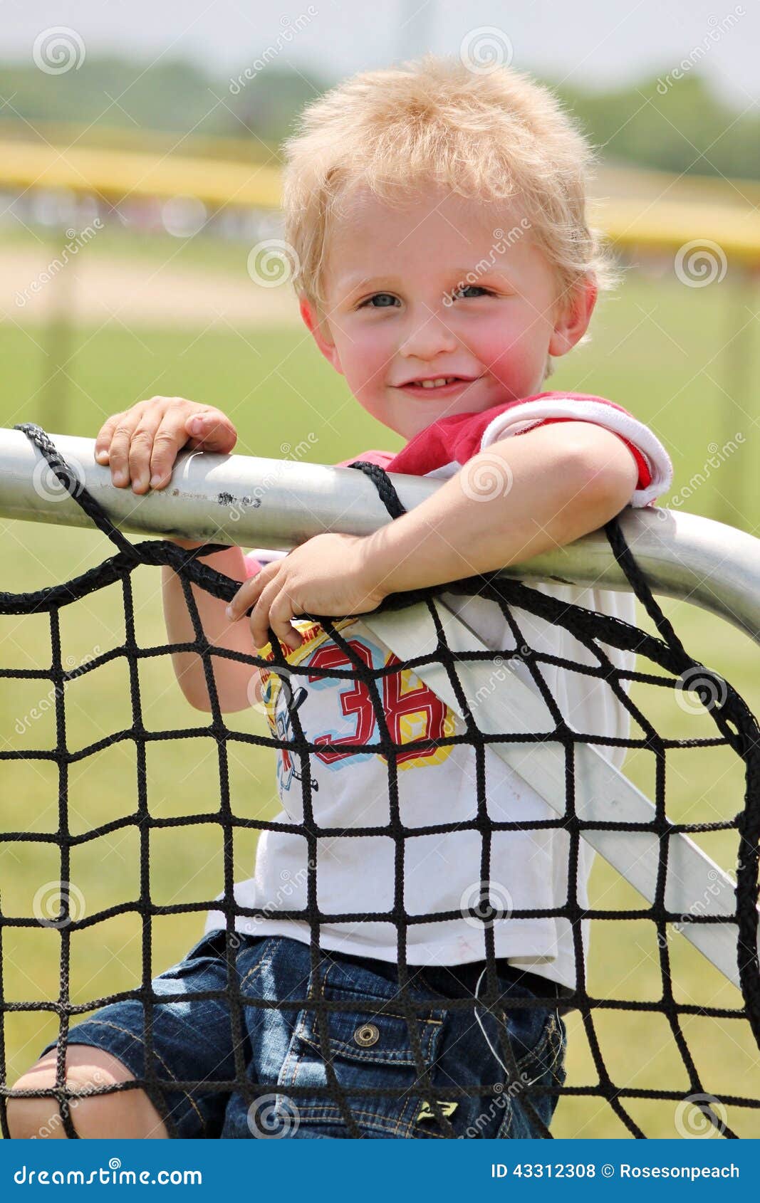 Adorable Toddler Boy Hanging on a Practice Net Stock Photo - Image of ...