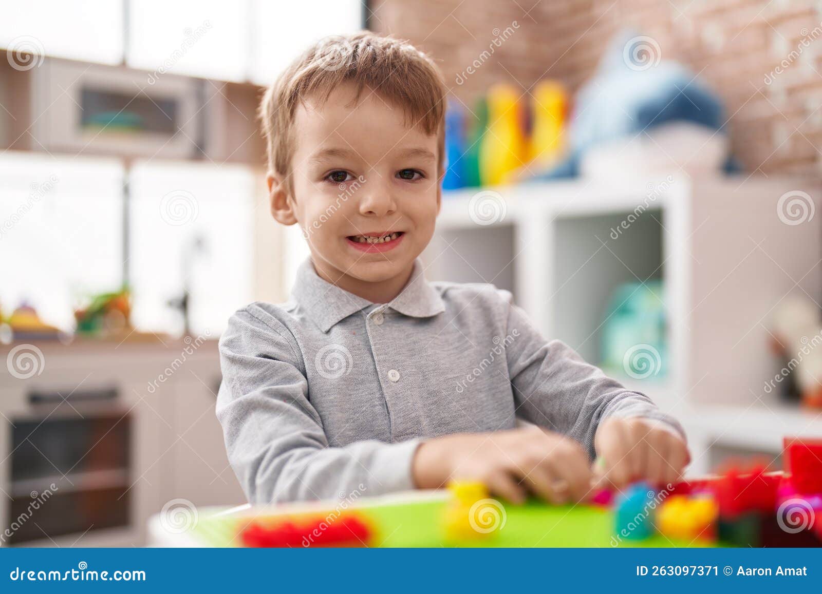 Adorable Toddler Playing with Construction Blocks Sitting on Table at ...