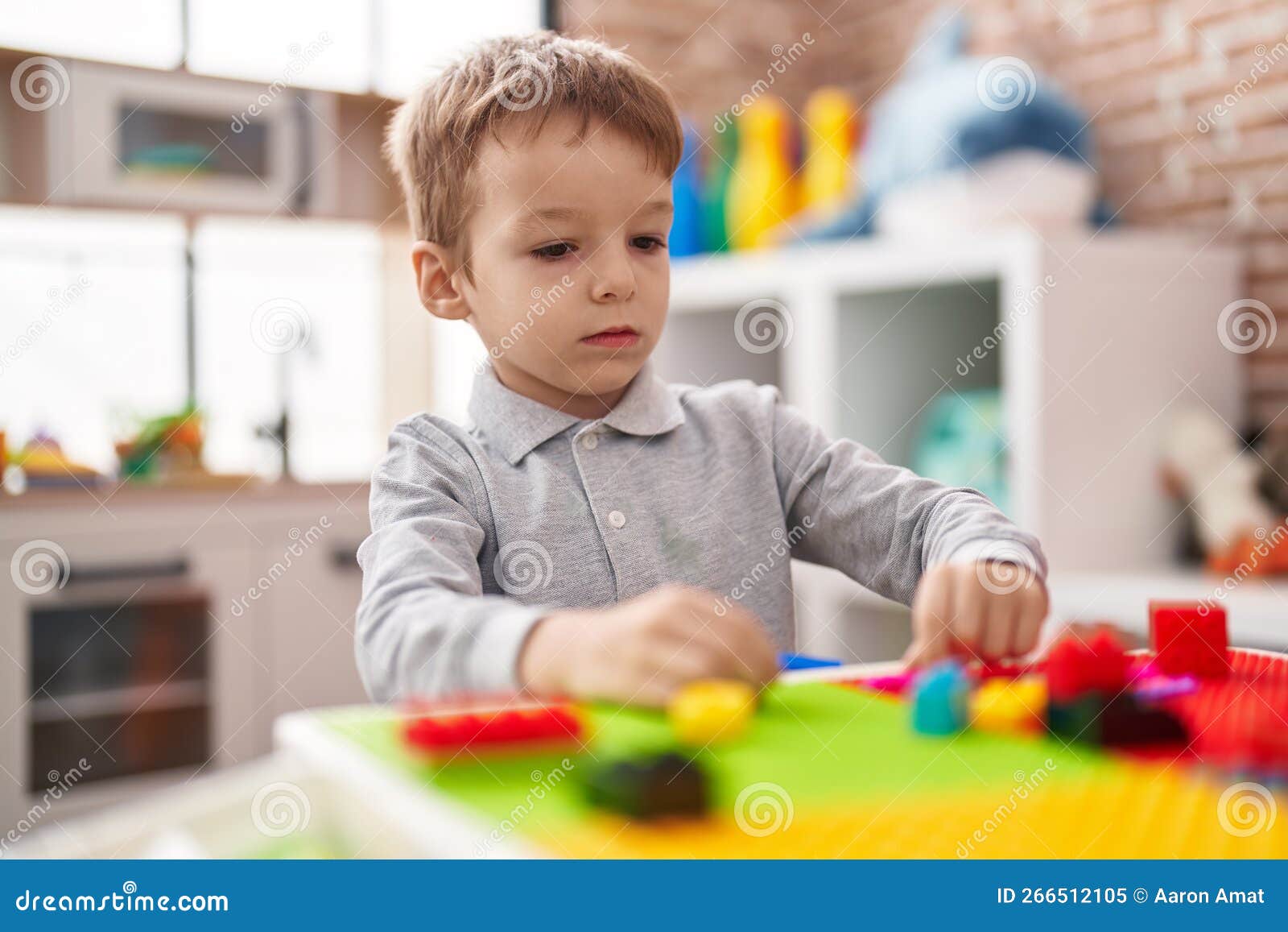 Adorable Toddler Playing with Construction Blocks Sitting on Table at ...