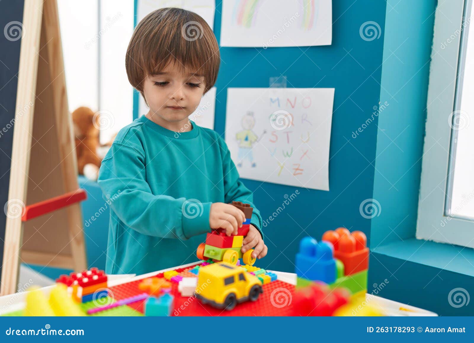 Adorable Toddler Playing with Construction Blocks Standing at ...