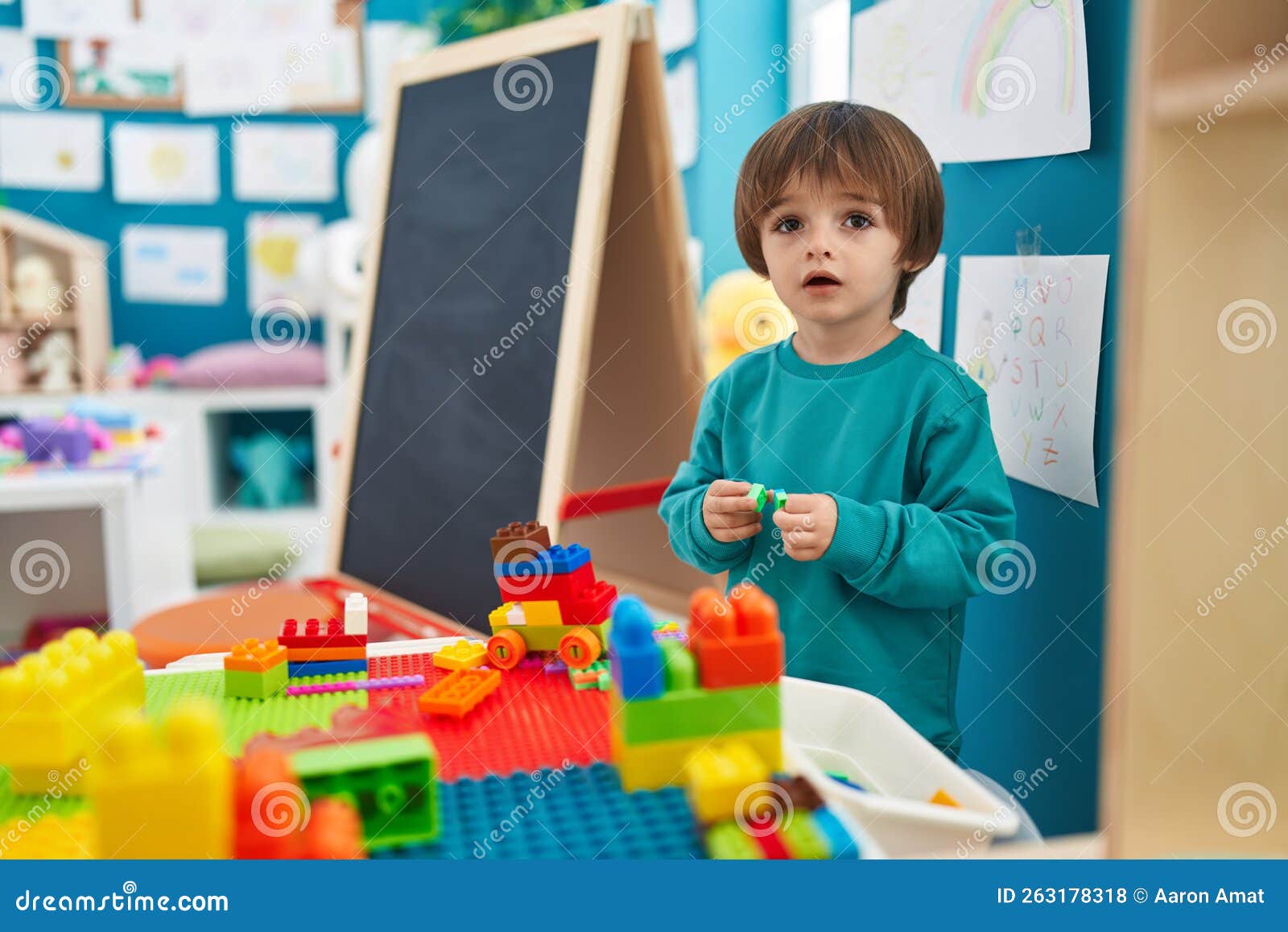 Adorable Toddler Playing with Construction Blocks Standing at ...