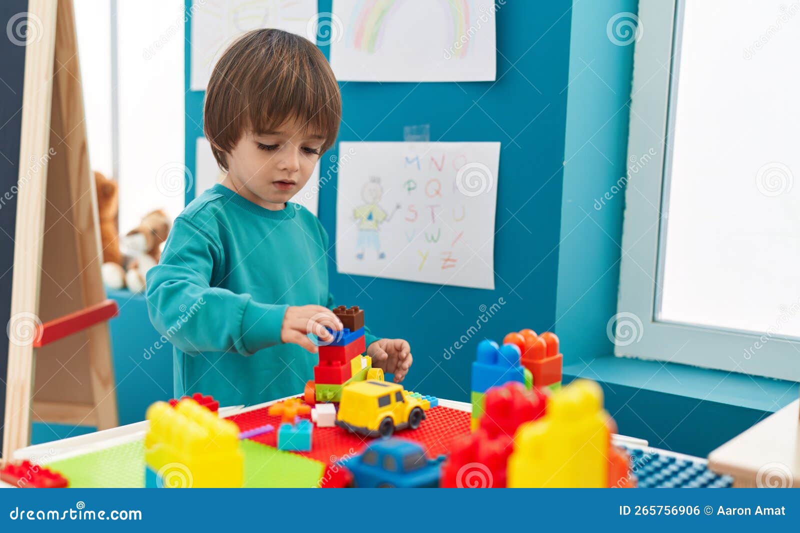 Adorable Toddler Playing with Construction Blocks Standing at ...