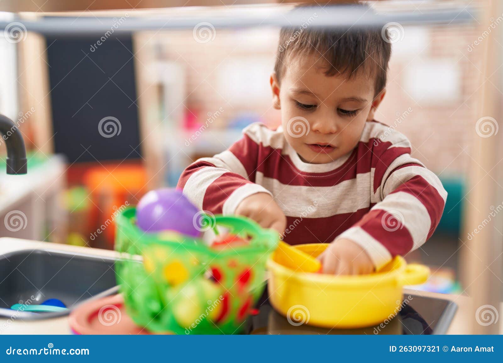 Adorable Toddler Playing with Play Kitchen Standing at Kindergarten ...