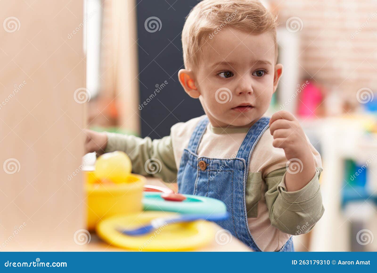 Adorable Toddler Playing with Play Kitchen Standing at Kindergarten ...