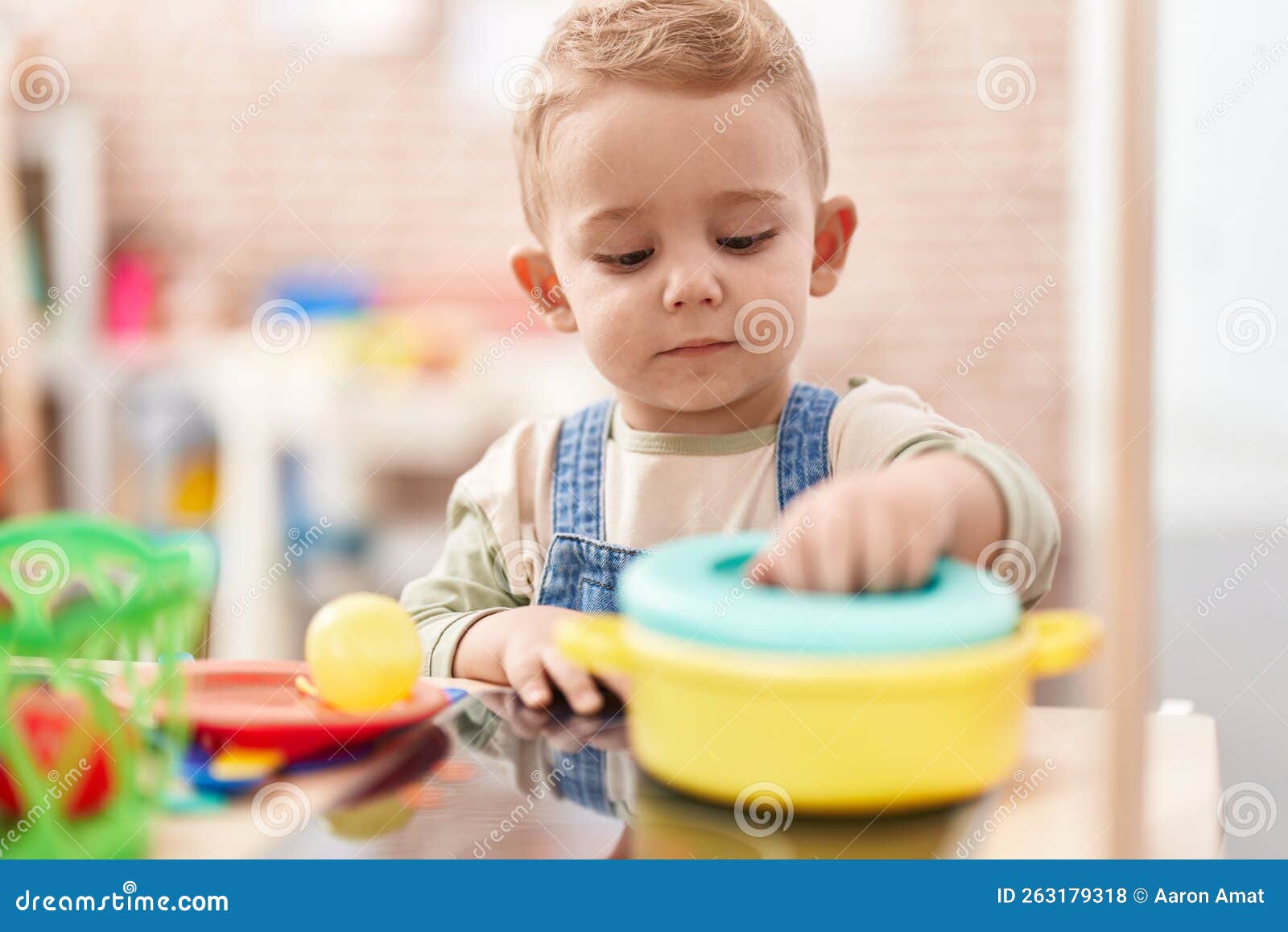 Adorable Toddler Playing with Play Kitchen Standing at Kindergarten ...