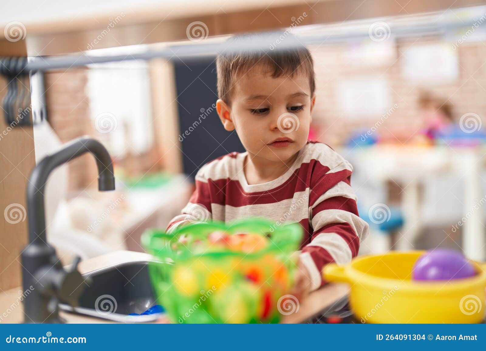 Adorable Toddler Playing with Play Kitchen Standing at Kindergarten ...