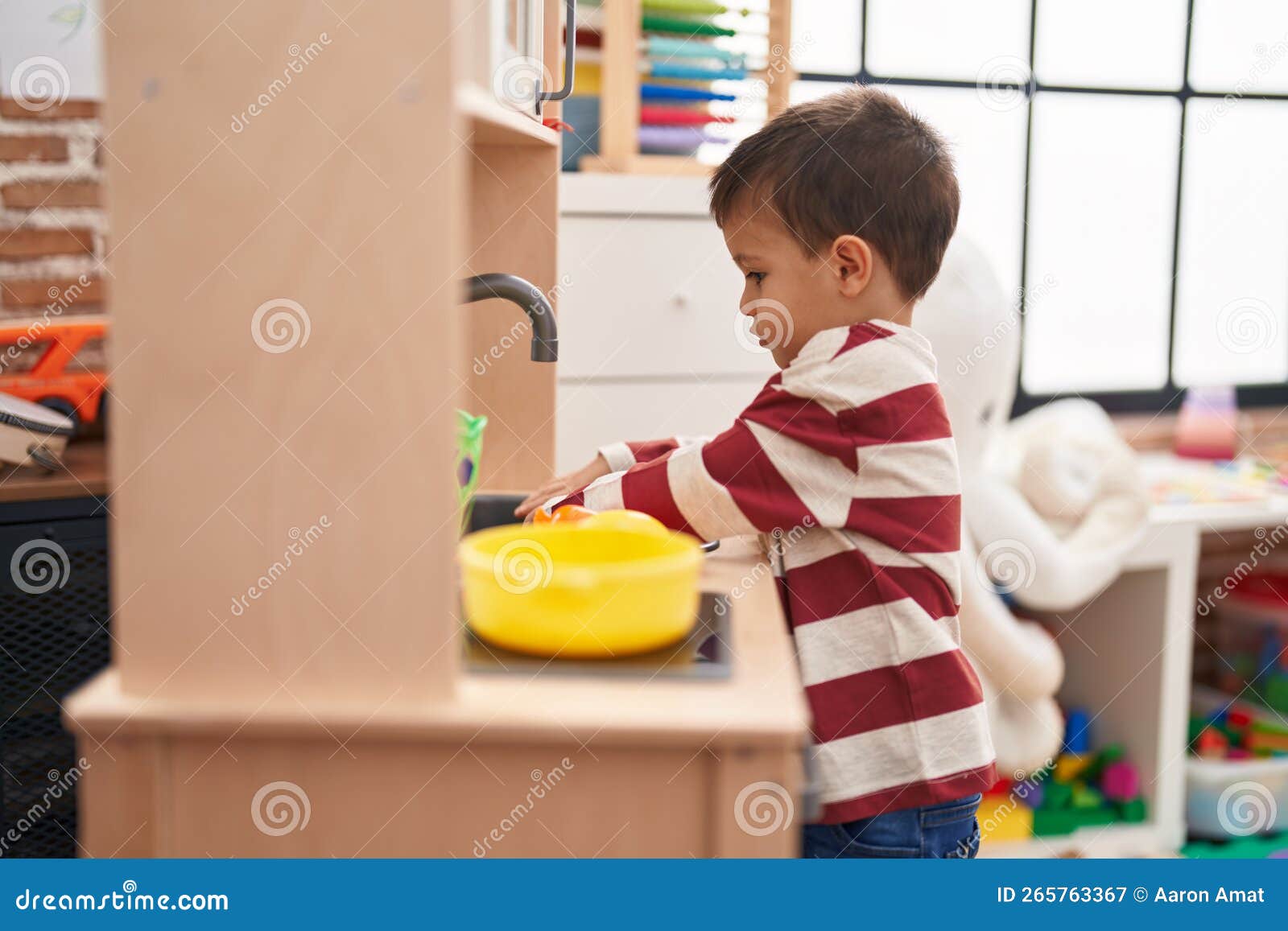 Adorable Toddler Playing with Play Kitchen Standing at Kindergarten ...