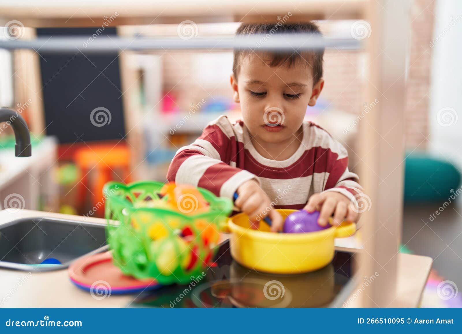 Adorable Toddler Playing with Play Kitchen Standing at Kindergarten ...