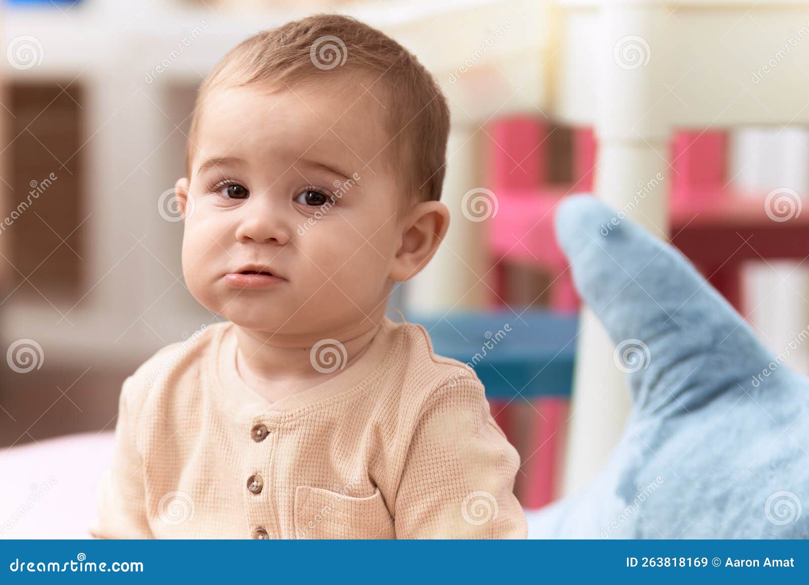 Adorable Toddler Sitting on Sofa with Sad Expression at Home Stock ...