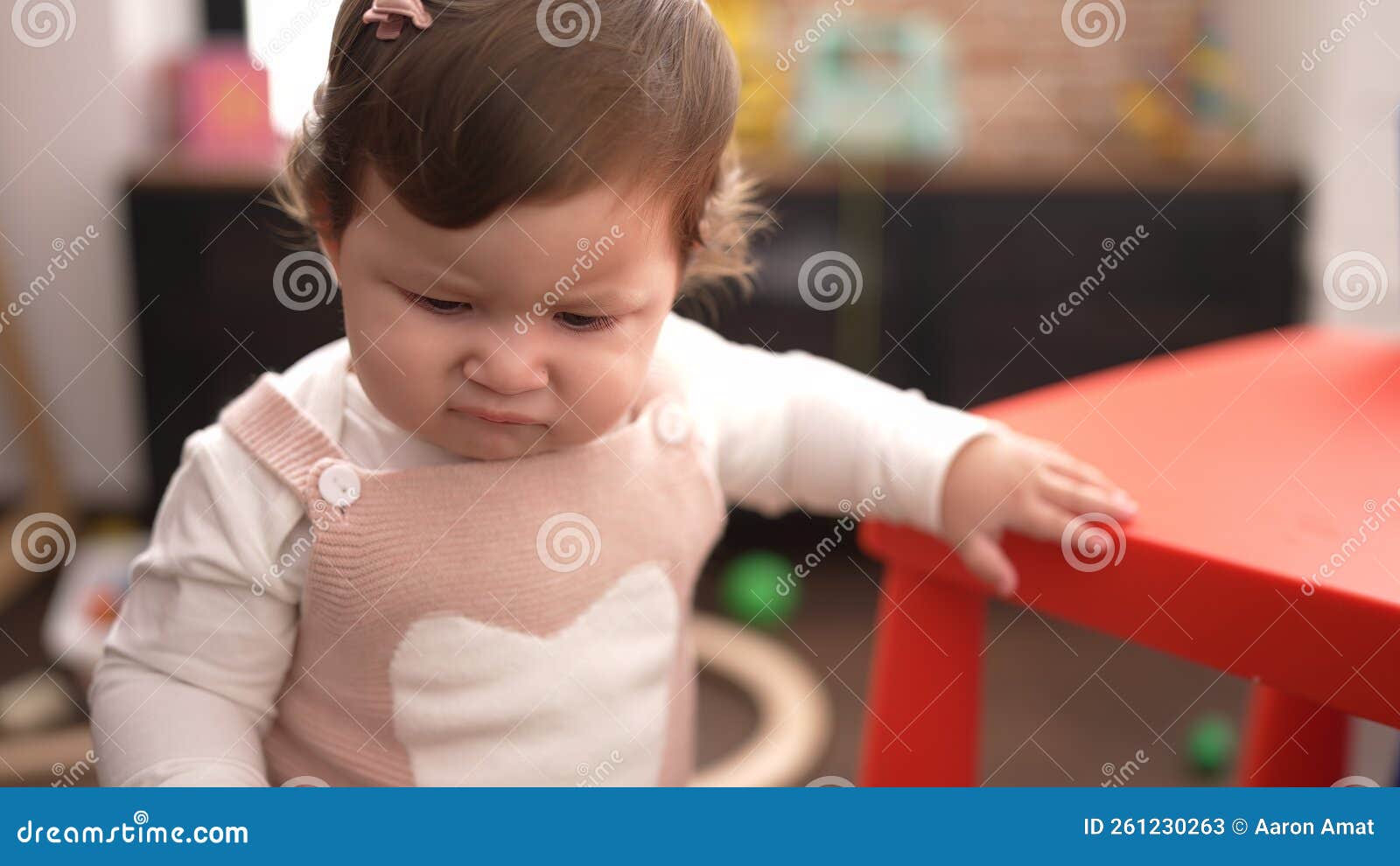 Adorable Toddler Standing with Relaxed Expression Leaning on Table at ...