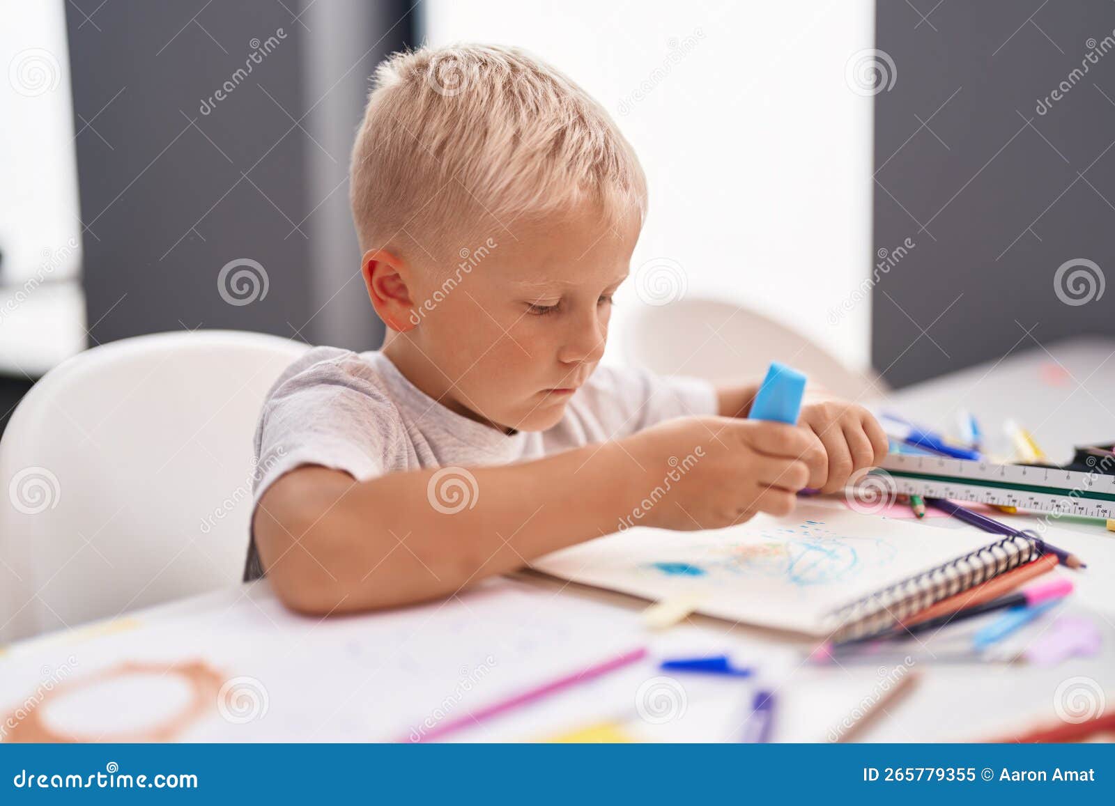 Adorable Toddler Student Drawing on Notebook Sitting on Table at ...