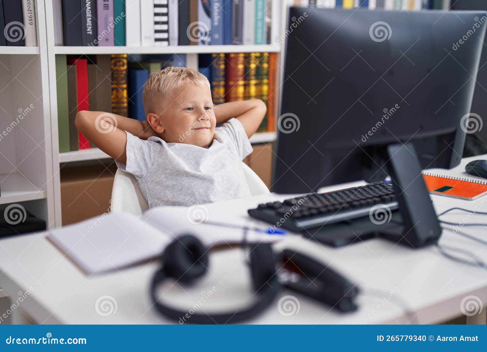 Adorable Toddler Student Using Computer Relaxed on Table at Classroom ...