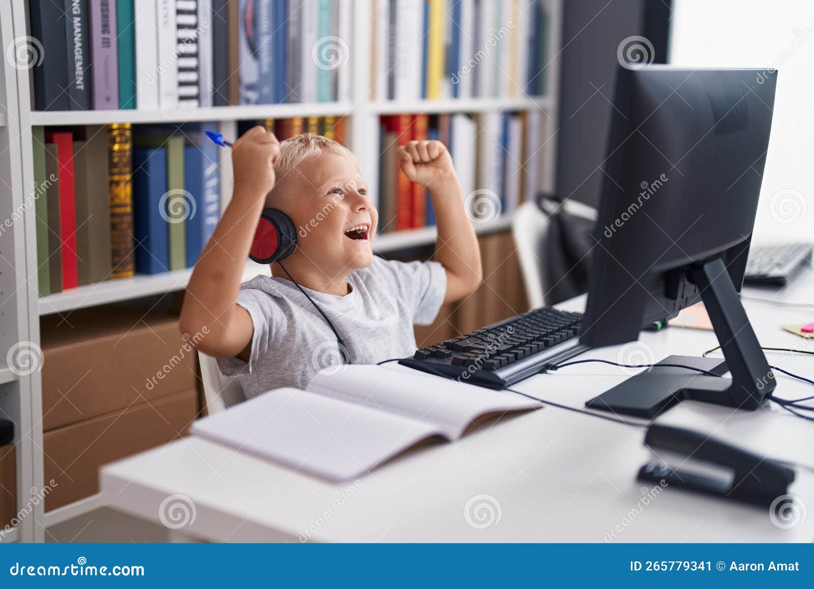 Adorable Toddler Student Using Computer with Winner Expression at ...