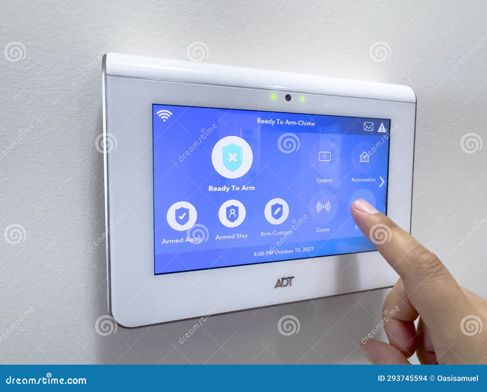 An ADT Security Panel Control on a Wall with a Person Using it ...