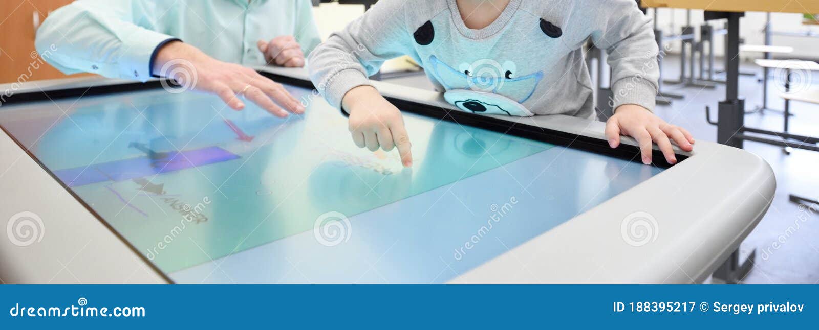 Adult and Child are Addicted To the Game on the Big Screen of the ...