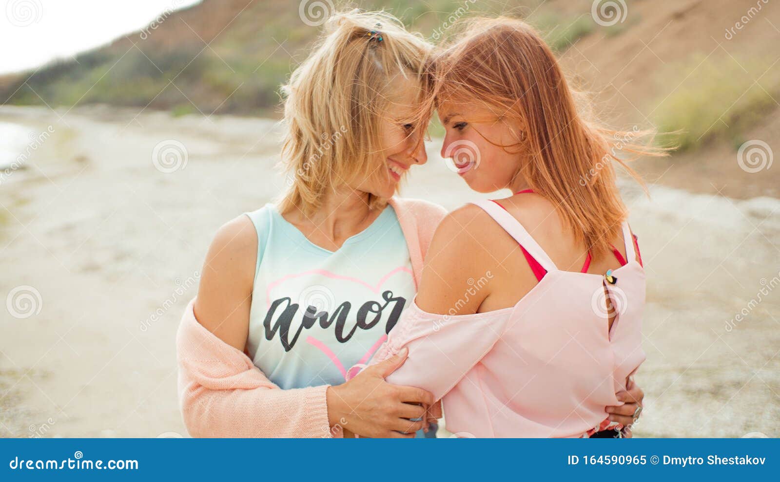 Adult Daughter And Mom Hugs On The Sea Shore And Both Are Smiling Stock