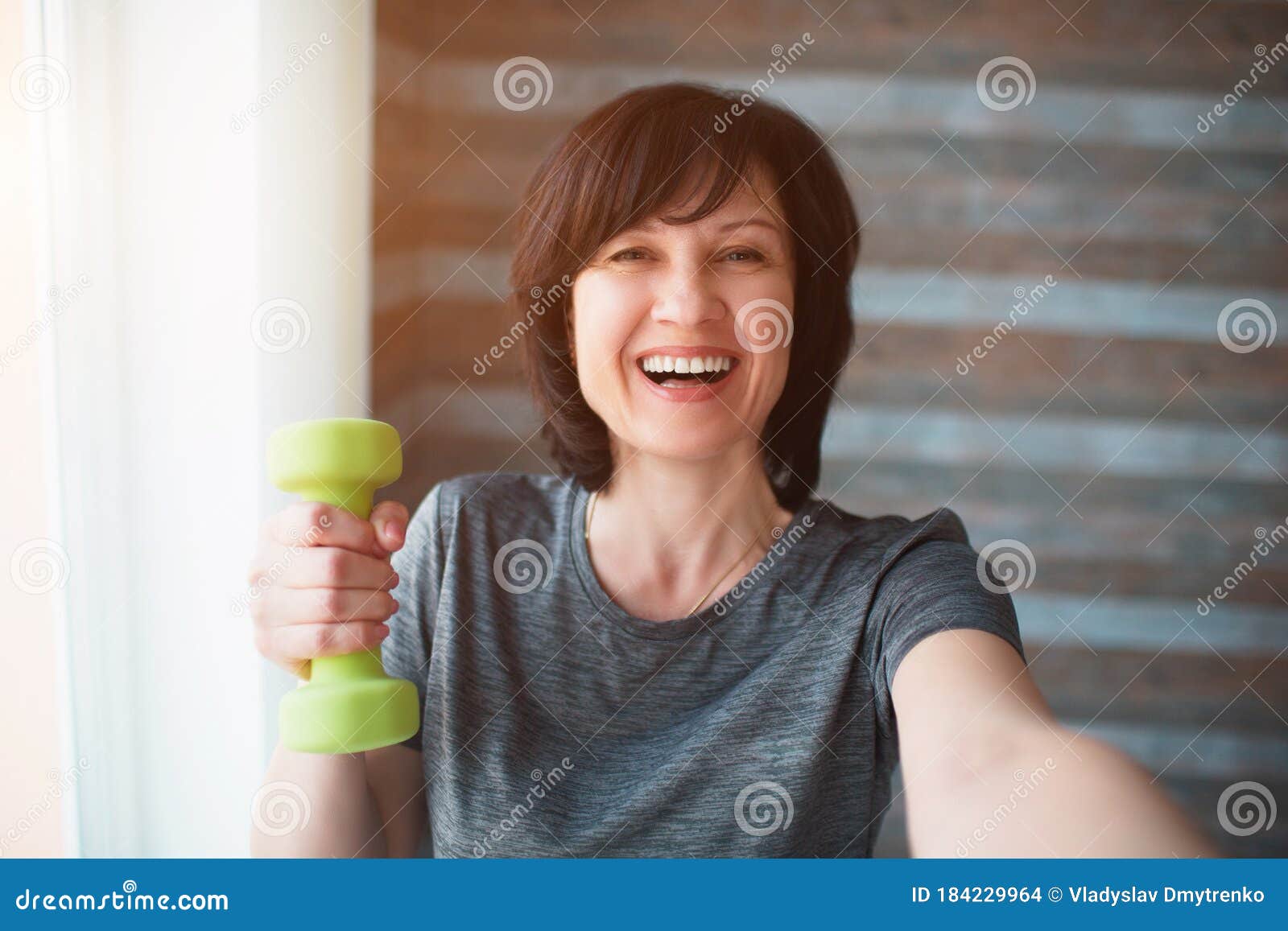 Adult Fit Slim Woman Has Workout at Home. Cheerful Positive Happy Adult ... Adult Fit Slim Woman Has Workout at Home. Cheerful Positive Happy Adult ...