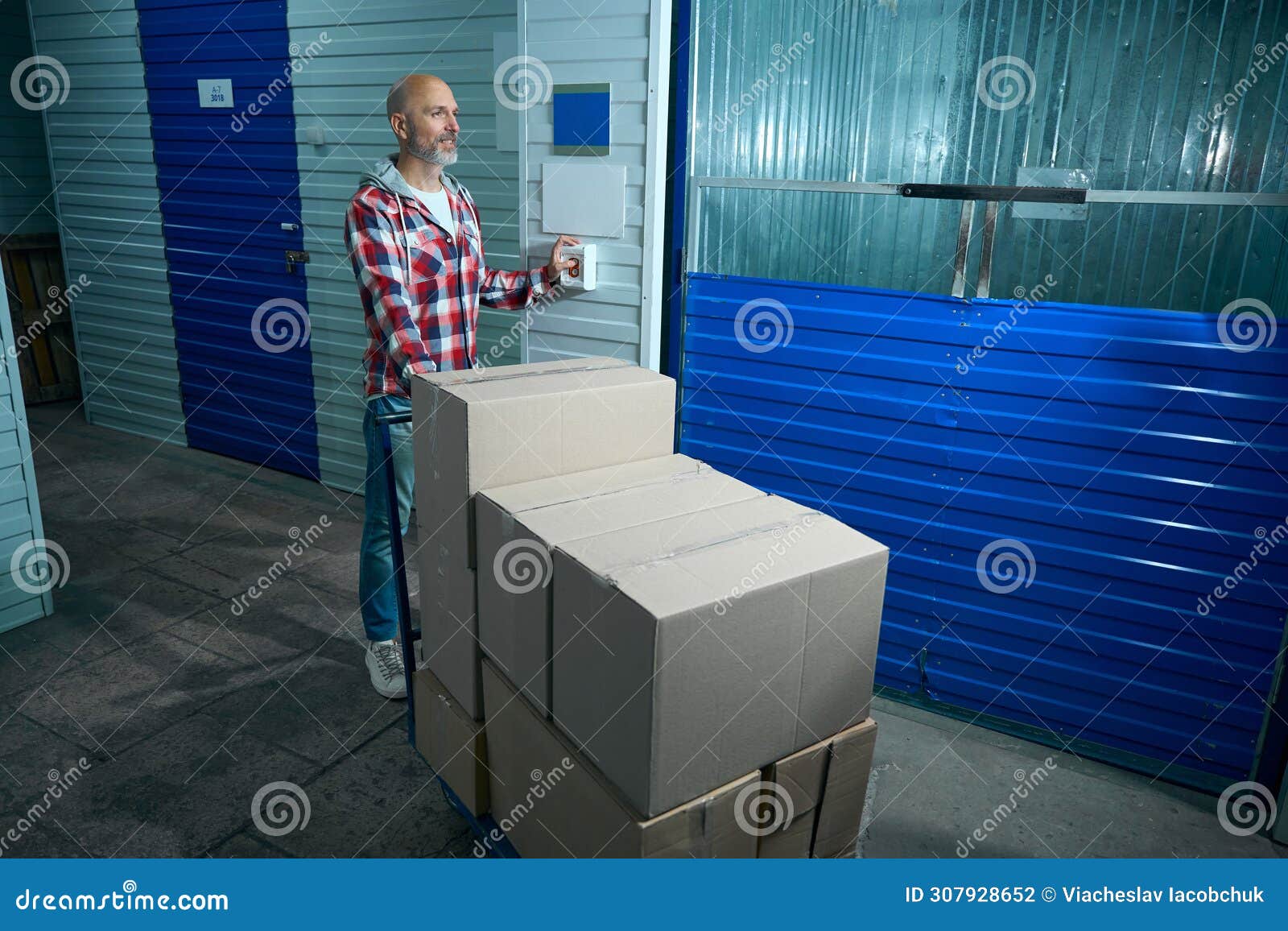 Adult Guy Opens a Storage Locker Roller Shutter Stock Photo - Image of ...