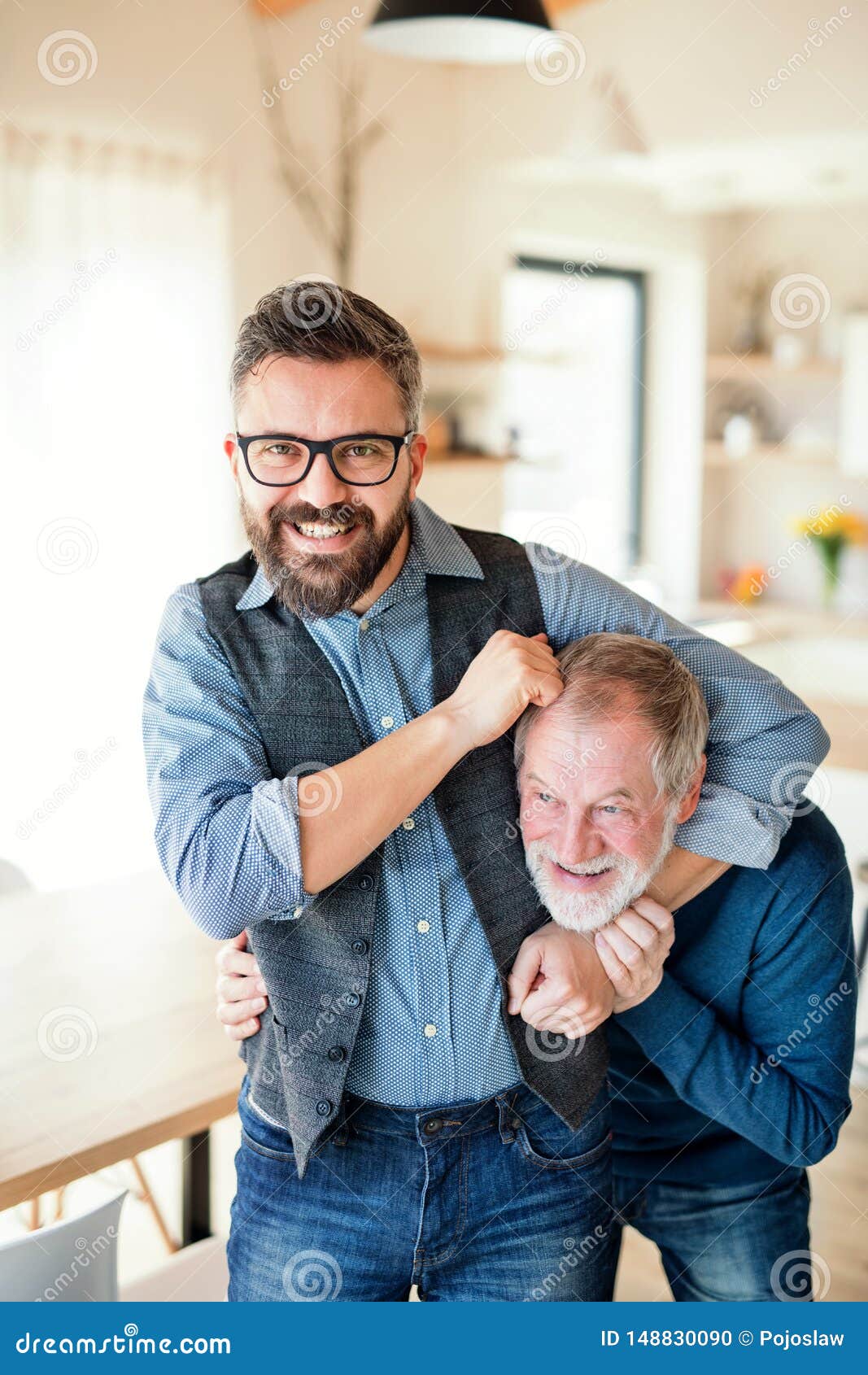 An Adult Hipster Son And Senior Father Indoors At Home Having Fun