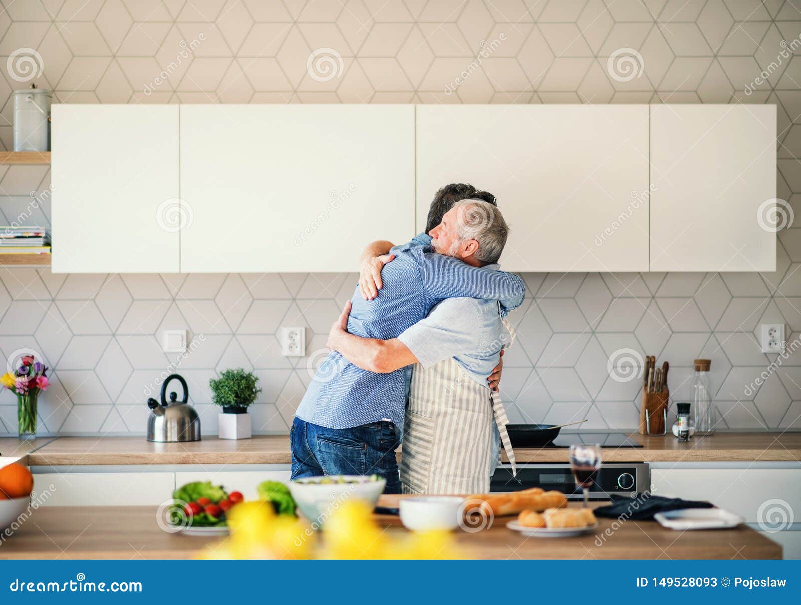 An Adult Hipster Son And Senior Father Indoors At Home Hugging When
