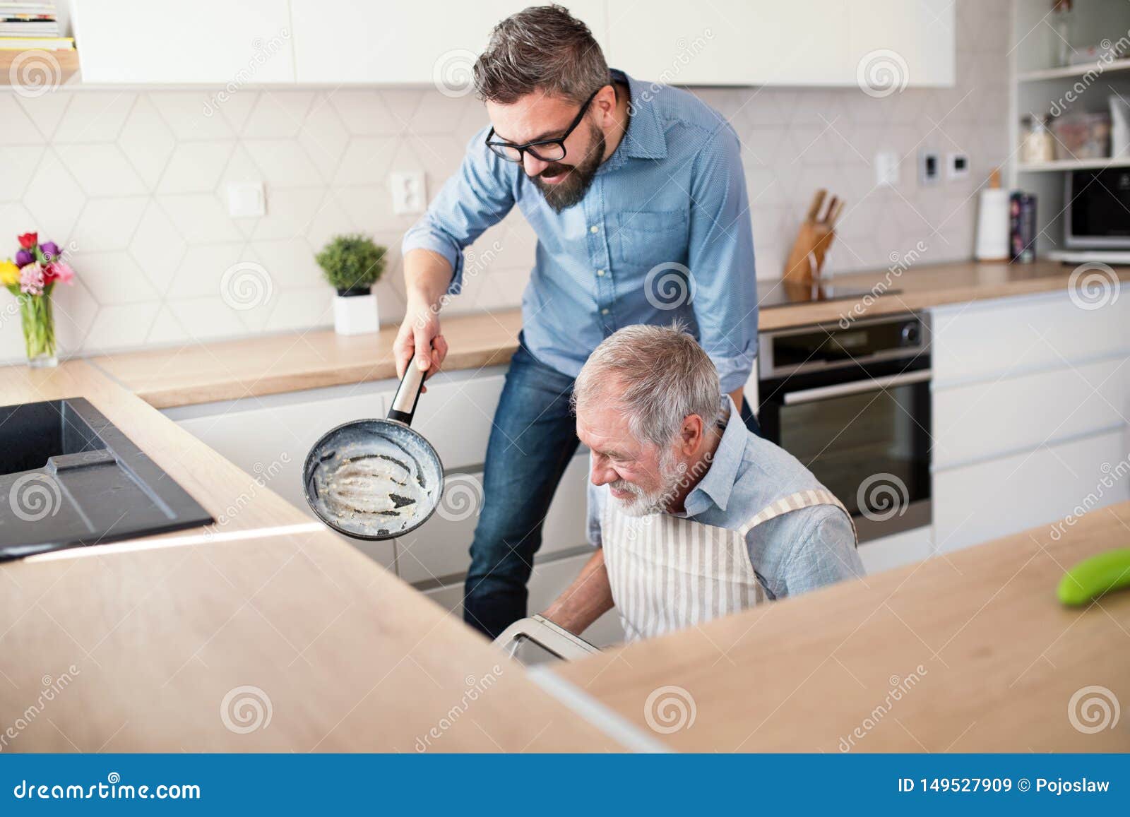 Adult Hipster Son And Senior Father Indoors In Kitchen At Home Cooking