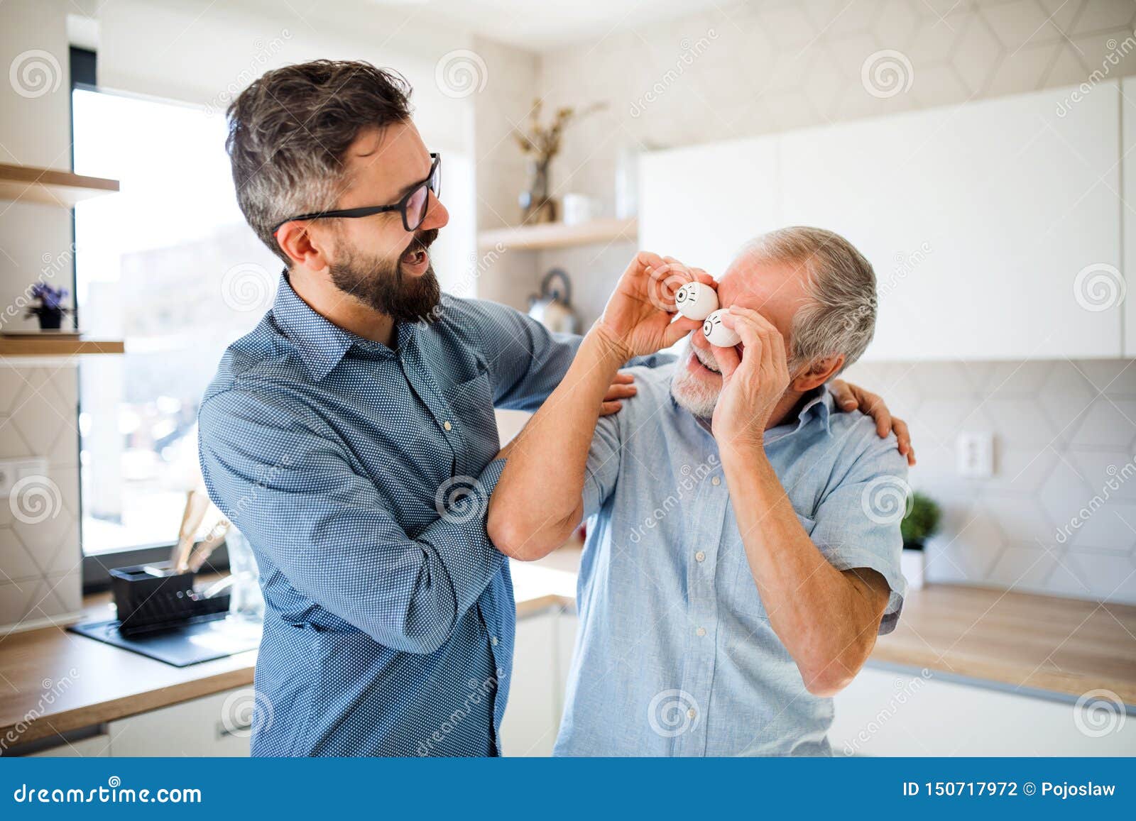 Adult Hipster Son And Senior Father Indoors In Kitchen At Home Having