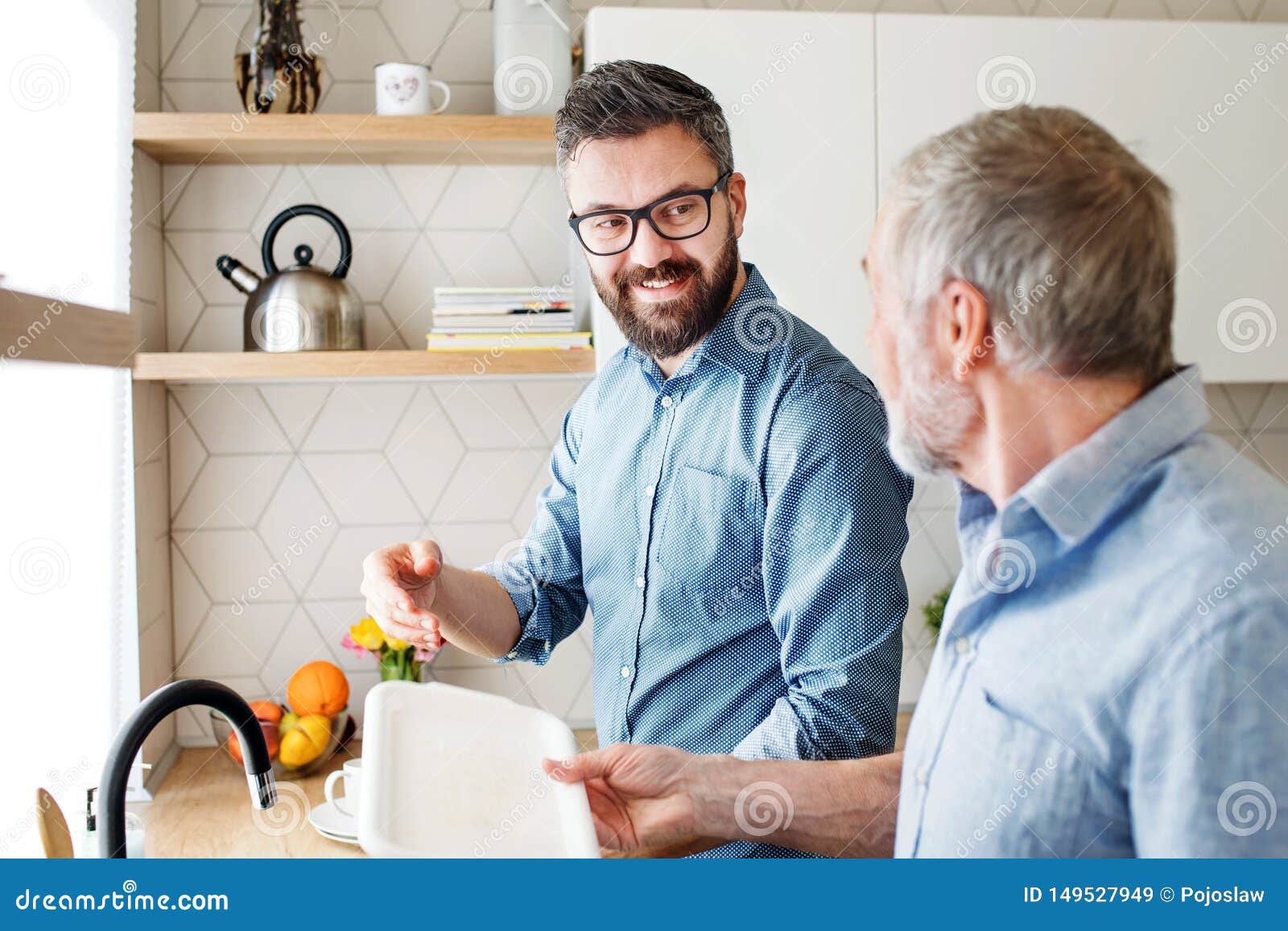 Adult Hipster Son And Senior Father Indoors In Kitchen At Home Washing