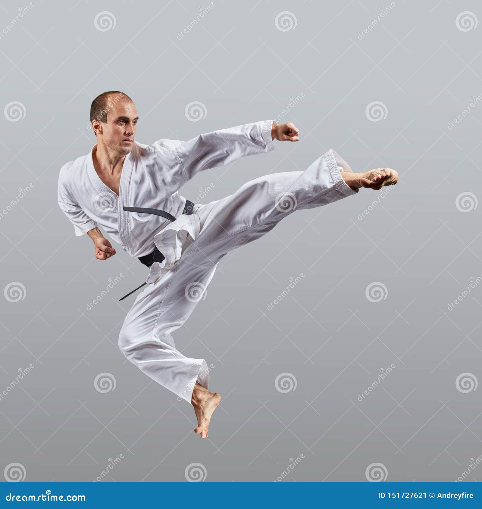 Adult Man Makes a Direct Kick on a Gray Background Stock Image - Image ...