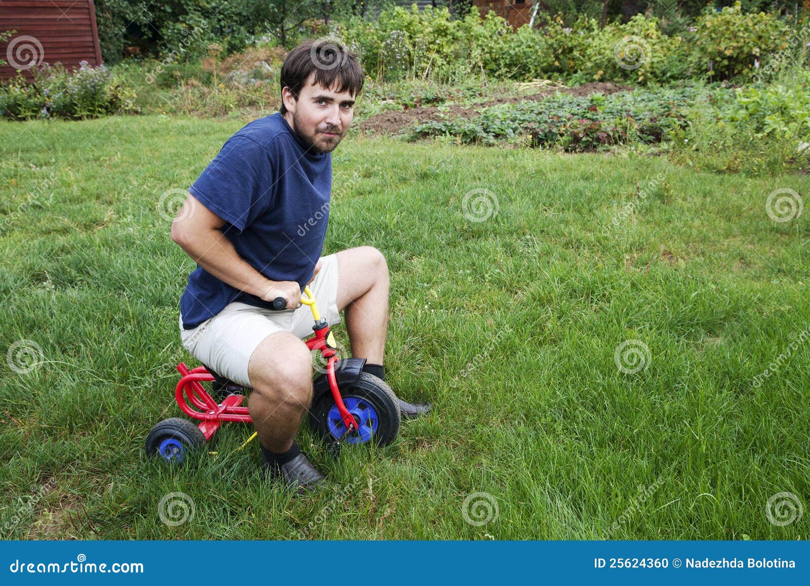 Adult Man on a Small Tricycle Stock Photo - Image of grass, contrast ...