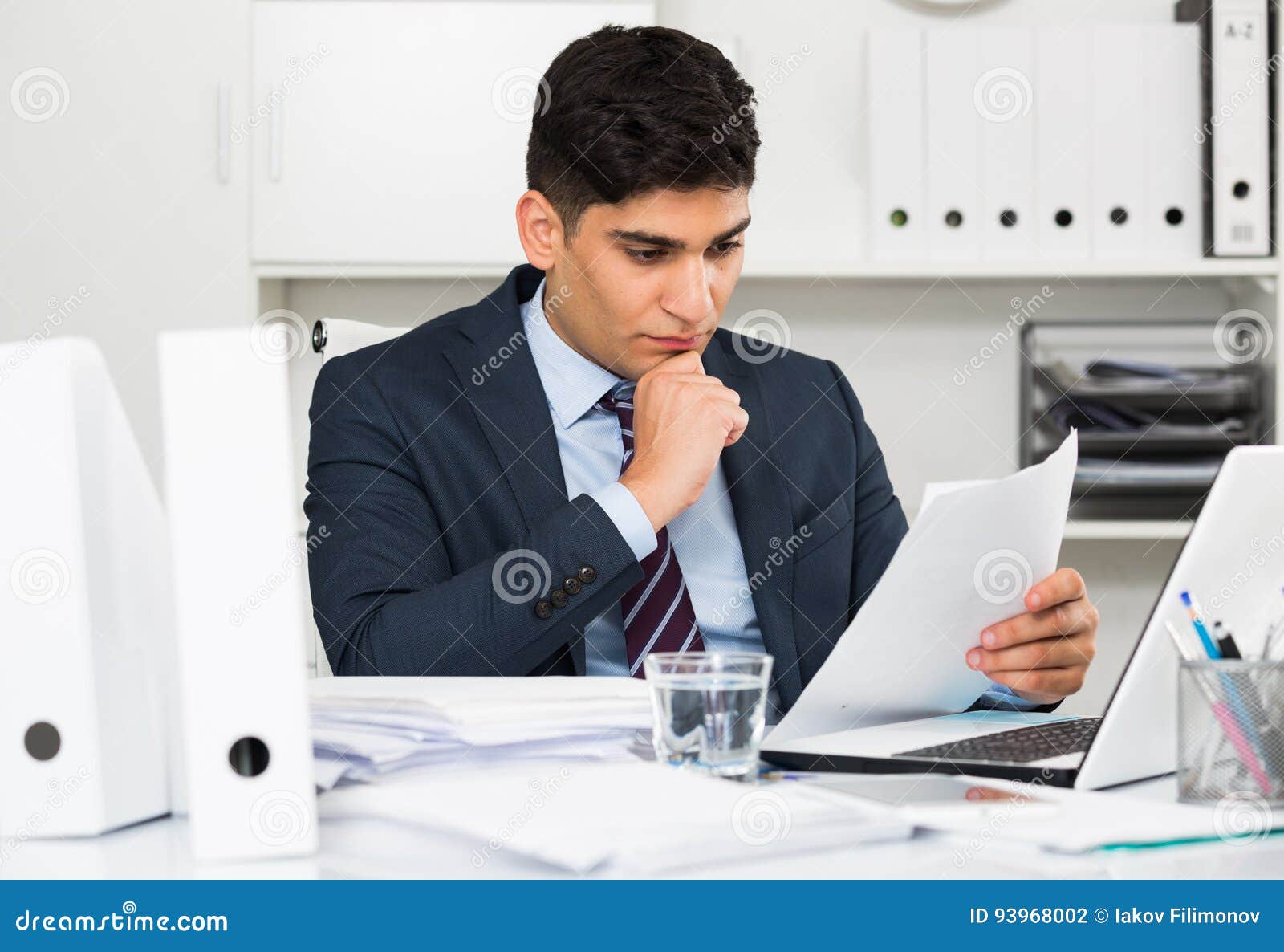 Adult Office Worker is Reading Documents about the Transaction Stock ...